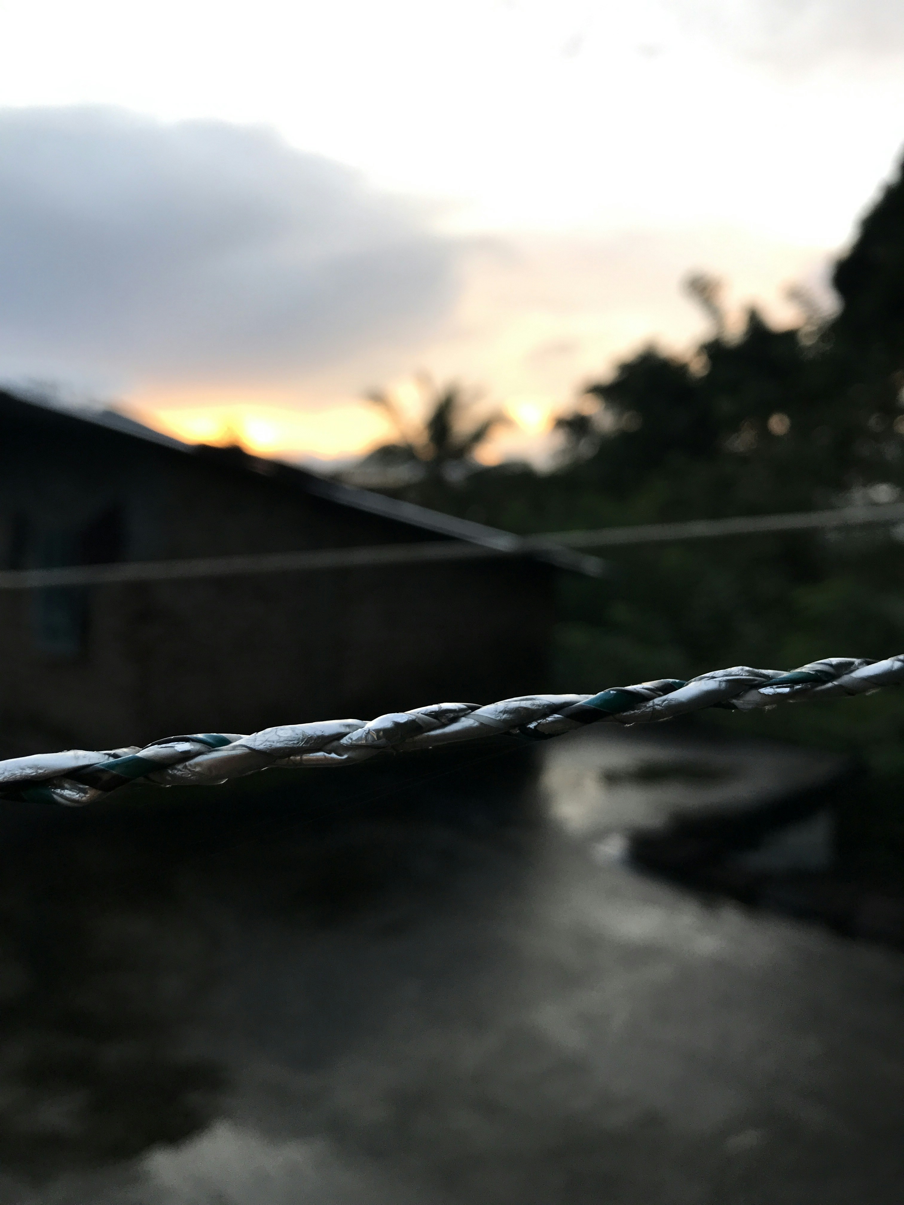 A close up of a rope with a house in the background photo – Free Sky ...