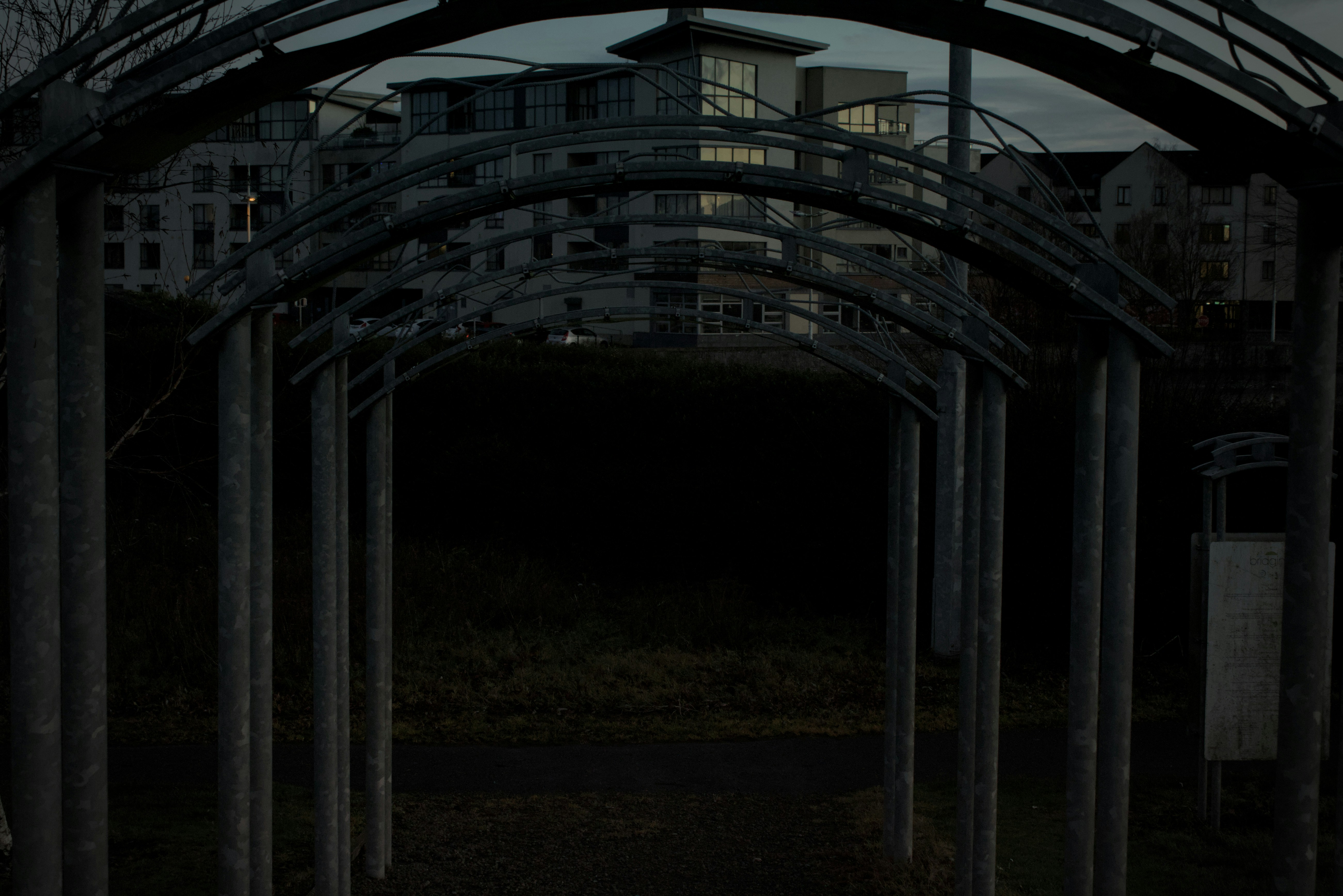 Between Steel Arches: A Dim Corridor Toward Hidden Light