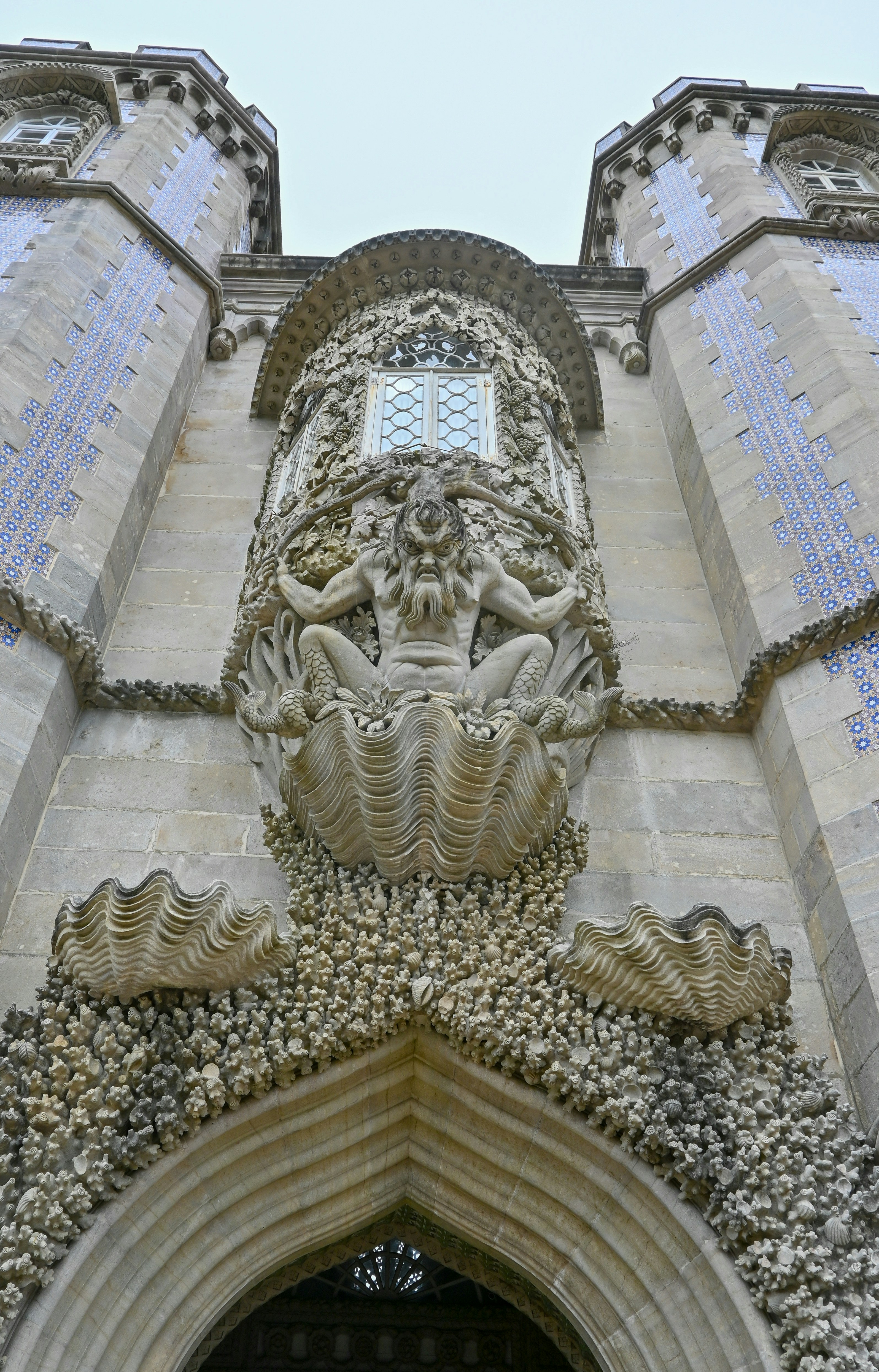 Leviathan at the Portal: Coral-Textured Gothic Facade