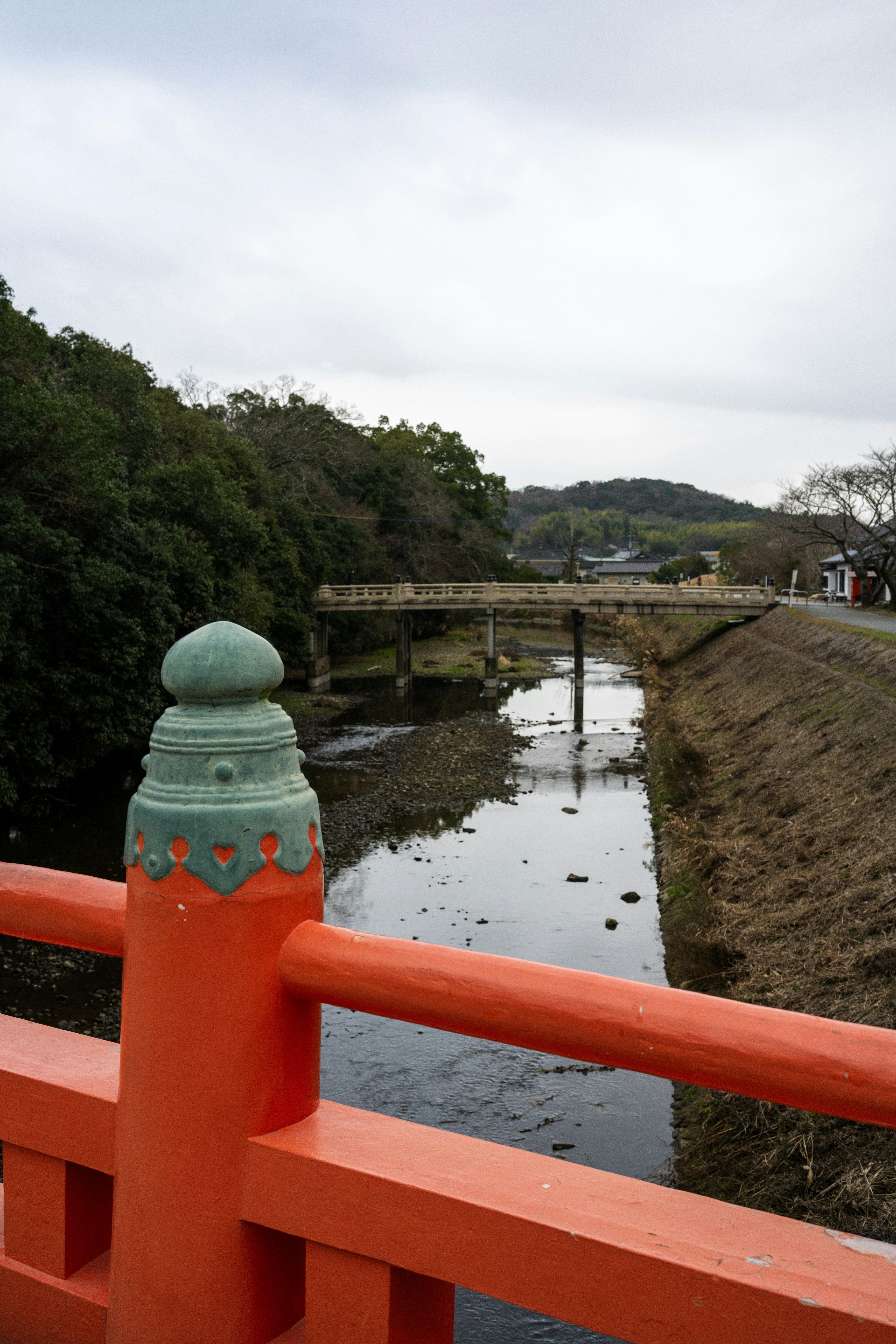 A red railing with a bridge in the background photo – Free Path Image ...