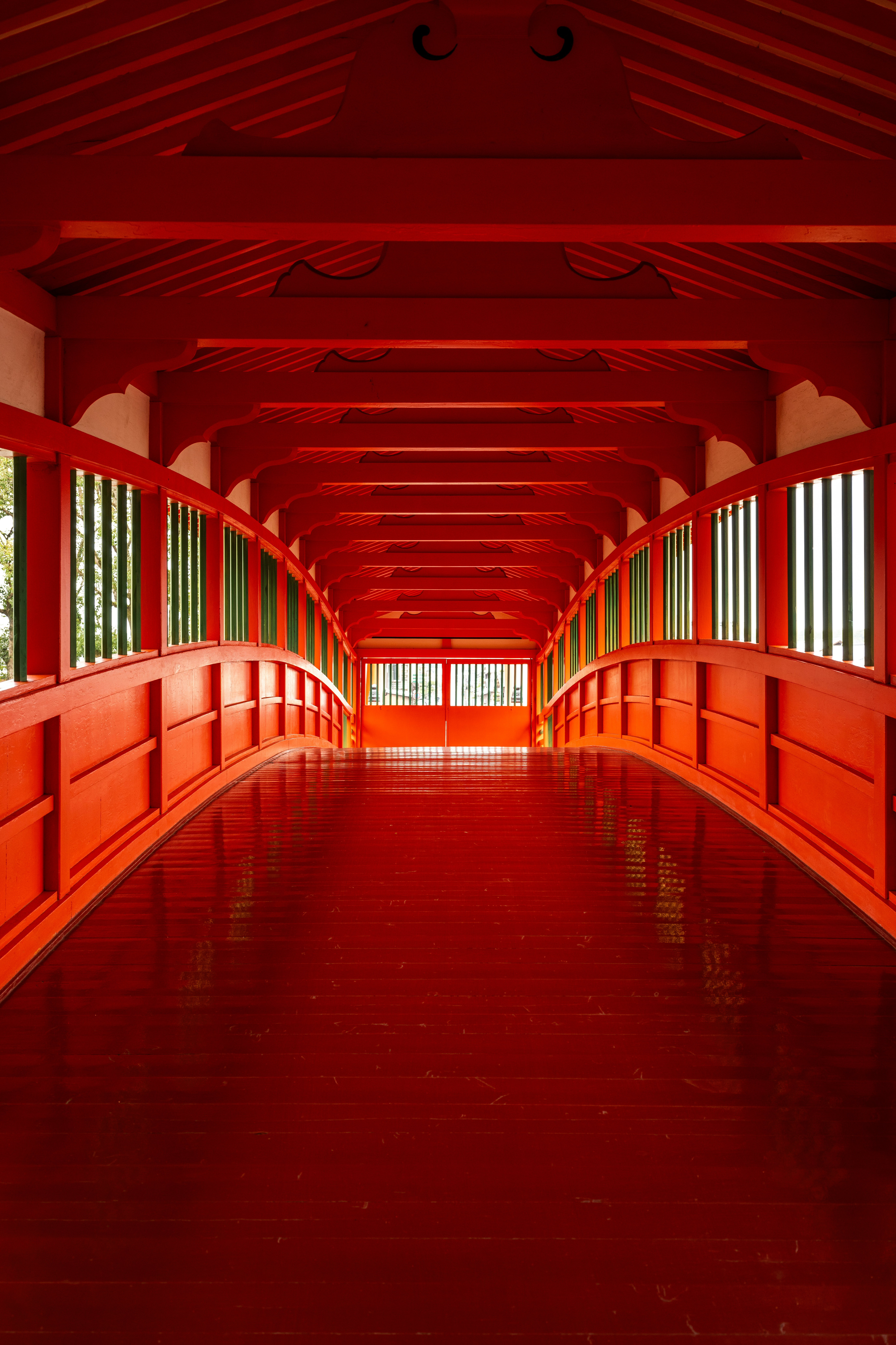 A long red walkway with windows and railings photo – Free Floor Image ...