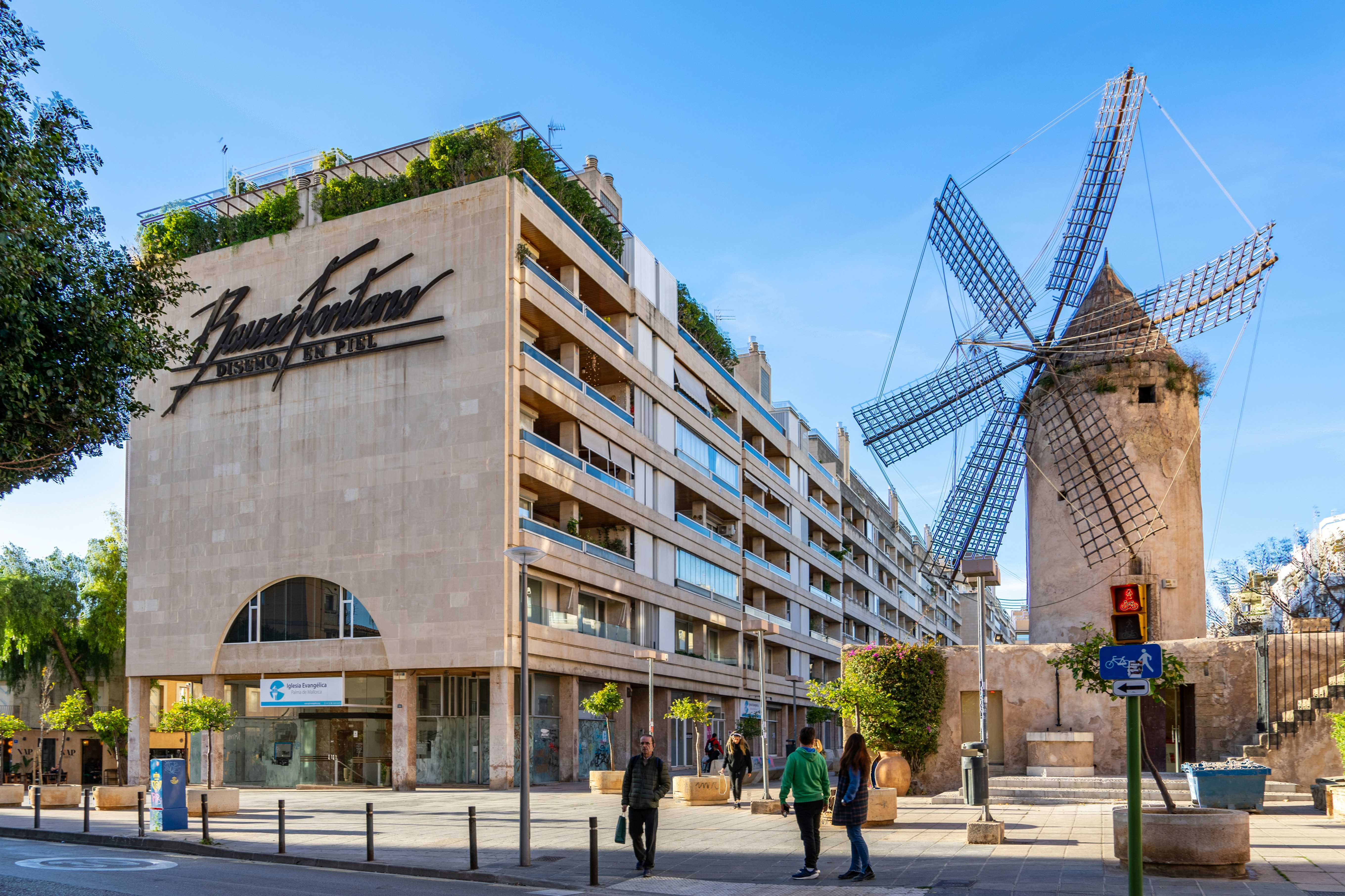 Historic windmill juxtaposed with contemporary architecture in a vibrant urban setting. A glimpse into the harmonious coexistence of past and present.