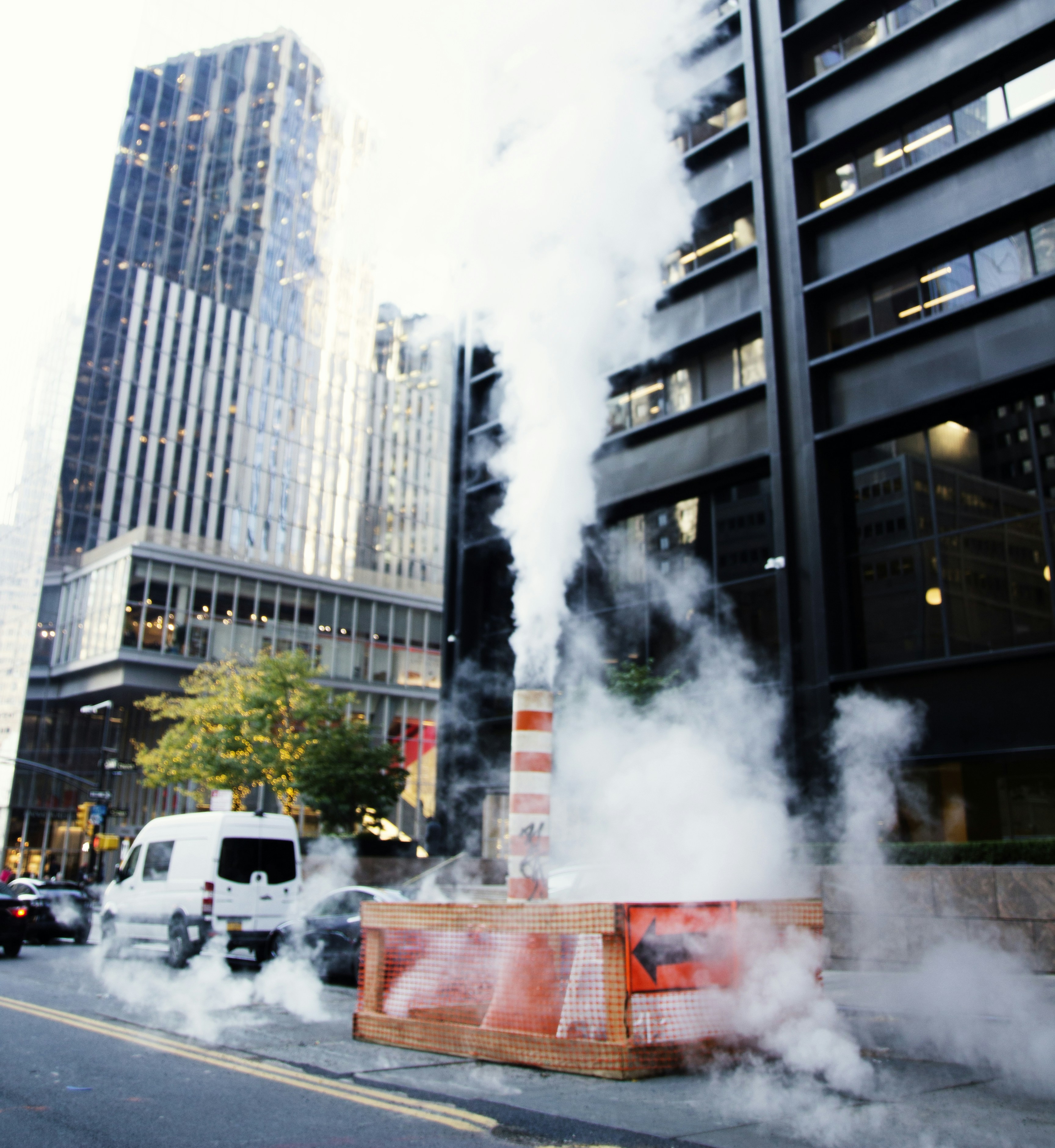 Midtown Steambreak: Street Vent Spews Mist Against Glass Towers