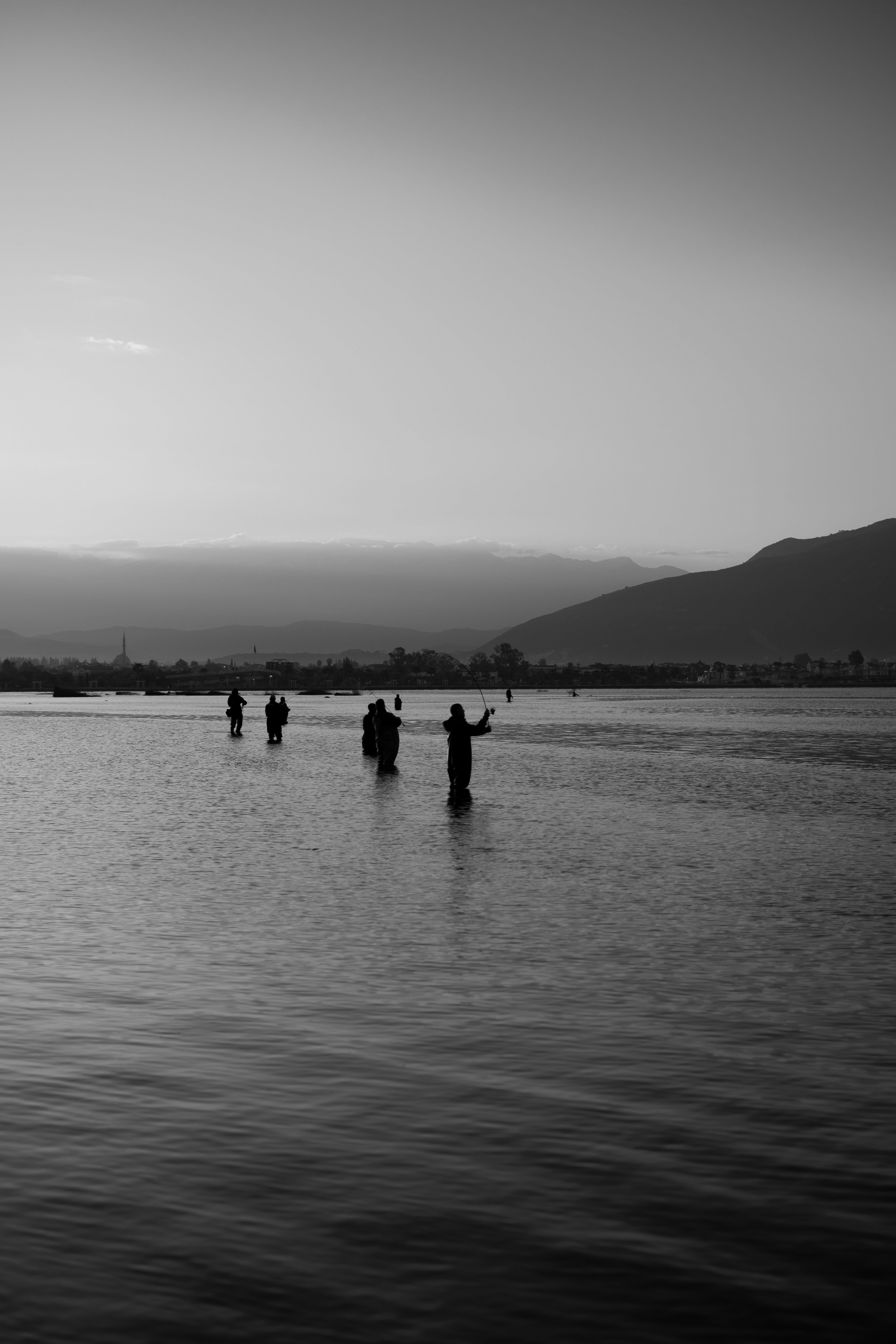 A group of people wading in a body of water photo – Free Sea Image on ...