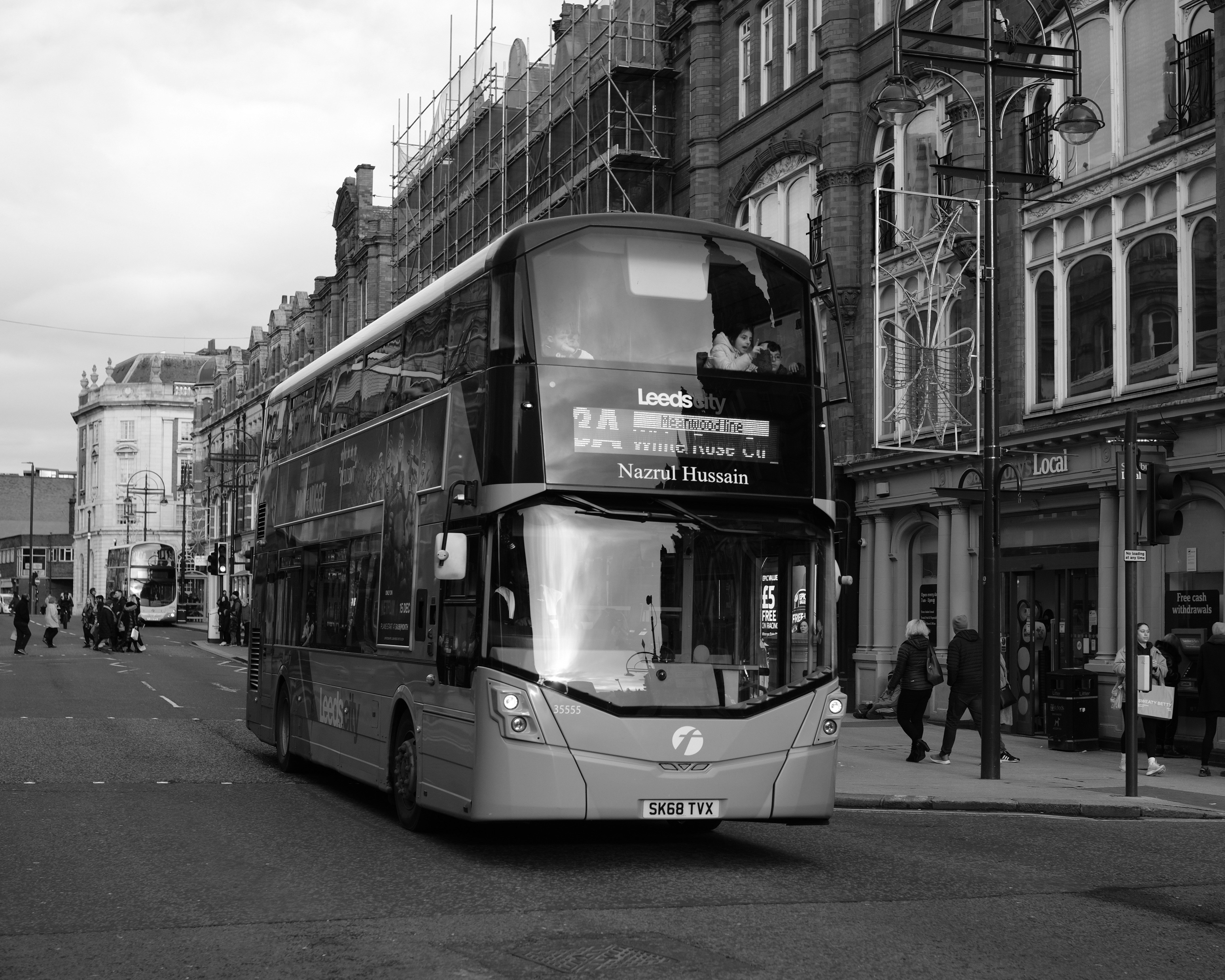 A double decker bus driving down a city street photo – Free Leeds Image ...