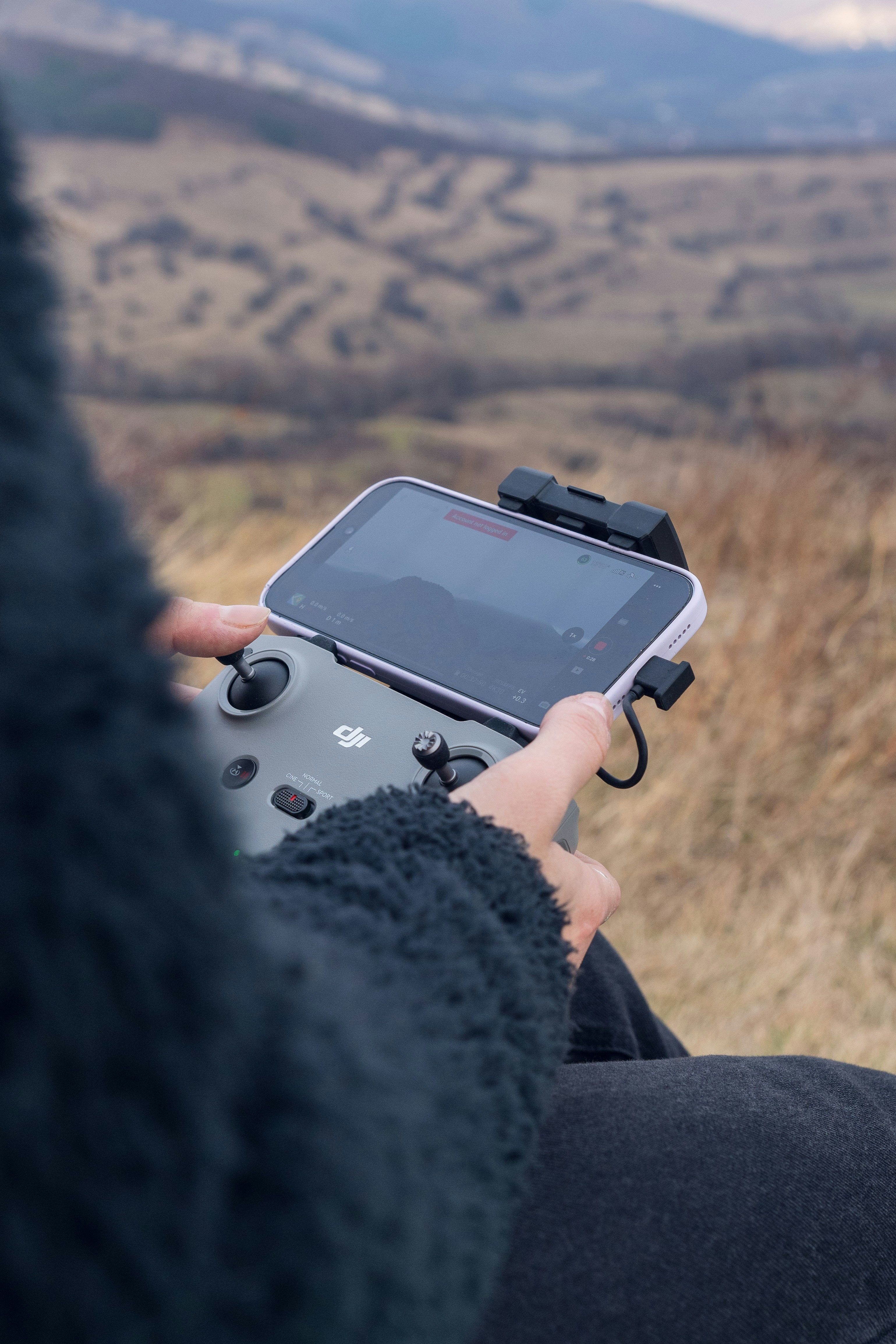 Control in the Field: A Drone-View of a Pilot Grasping the Controller