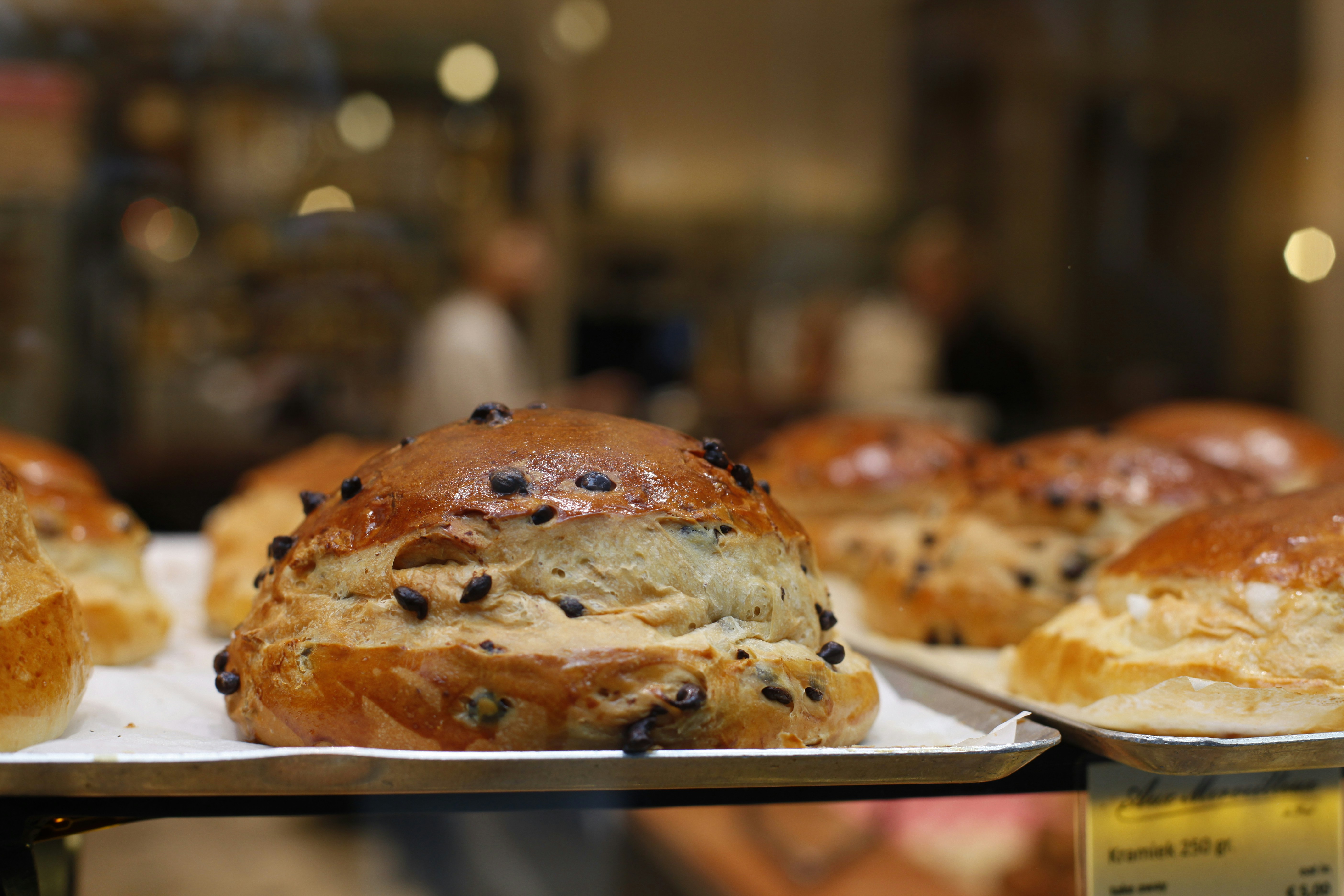 Sesame-kissed bagels glow in a bakery case