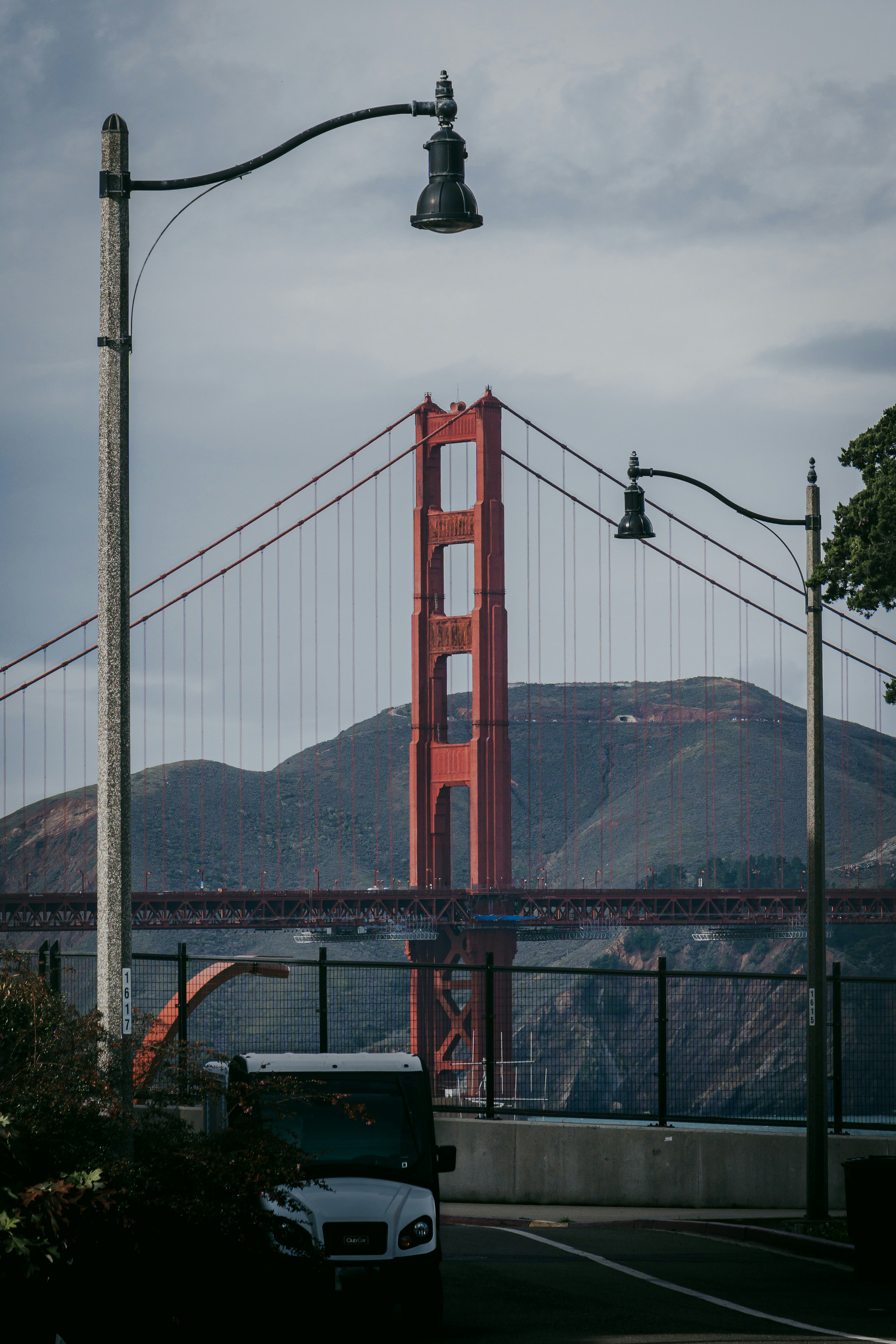 Crimson Gateframe: Golden Gate Tower Framed by Street Lamps