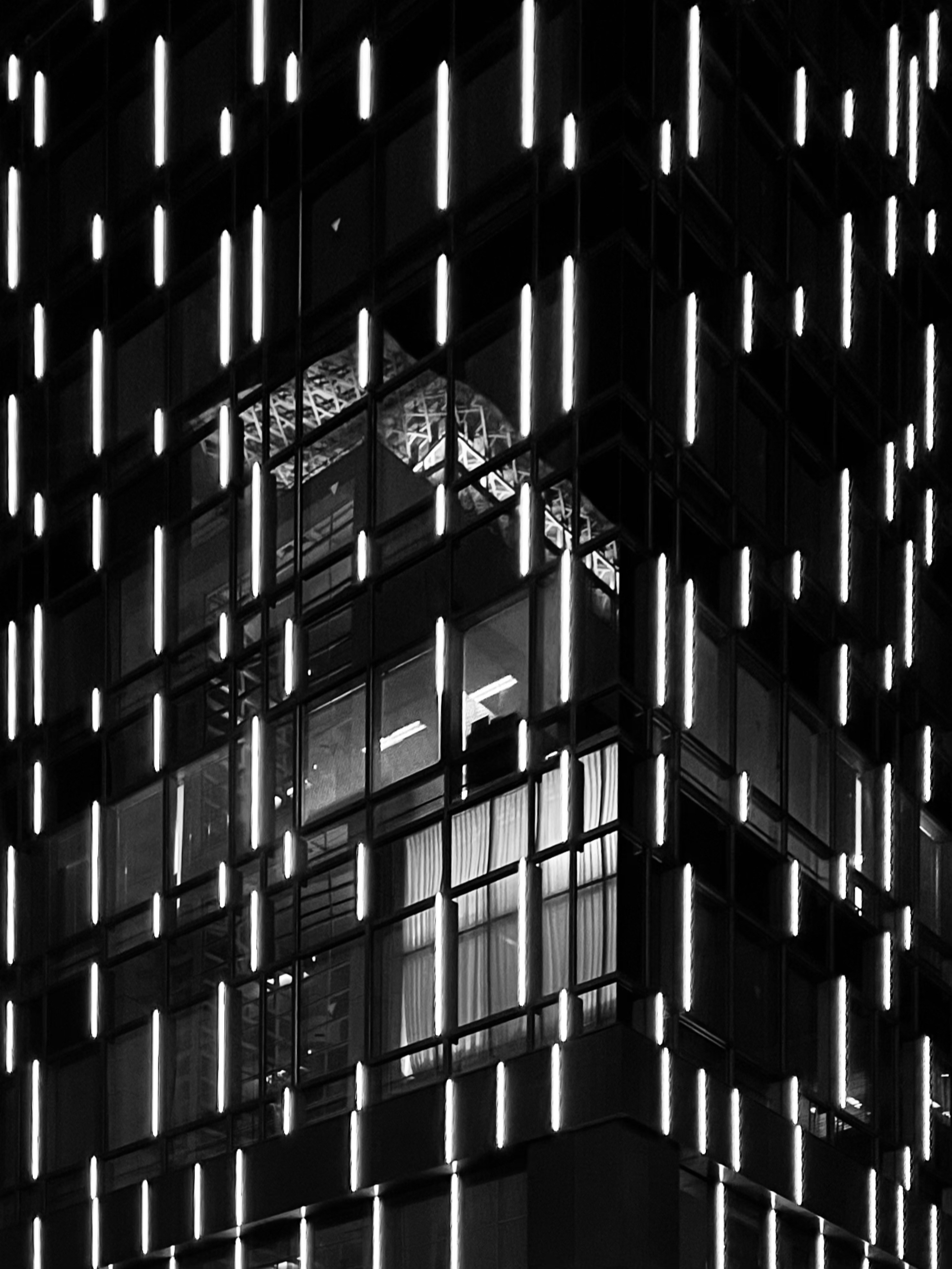 Luminous Grid: Neon Rain on a Glass Facade