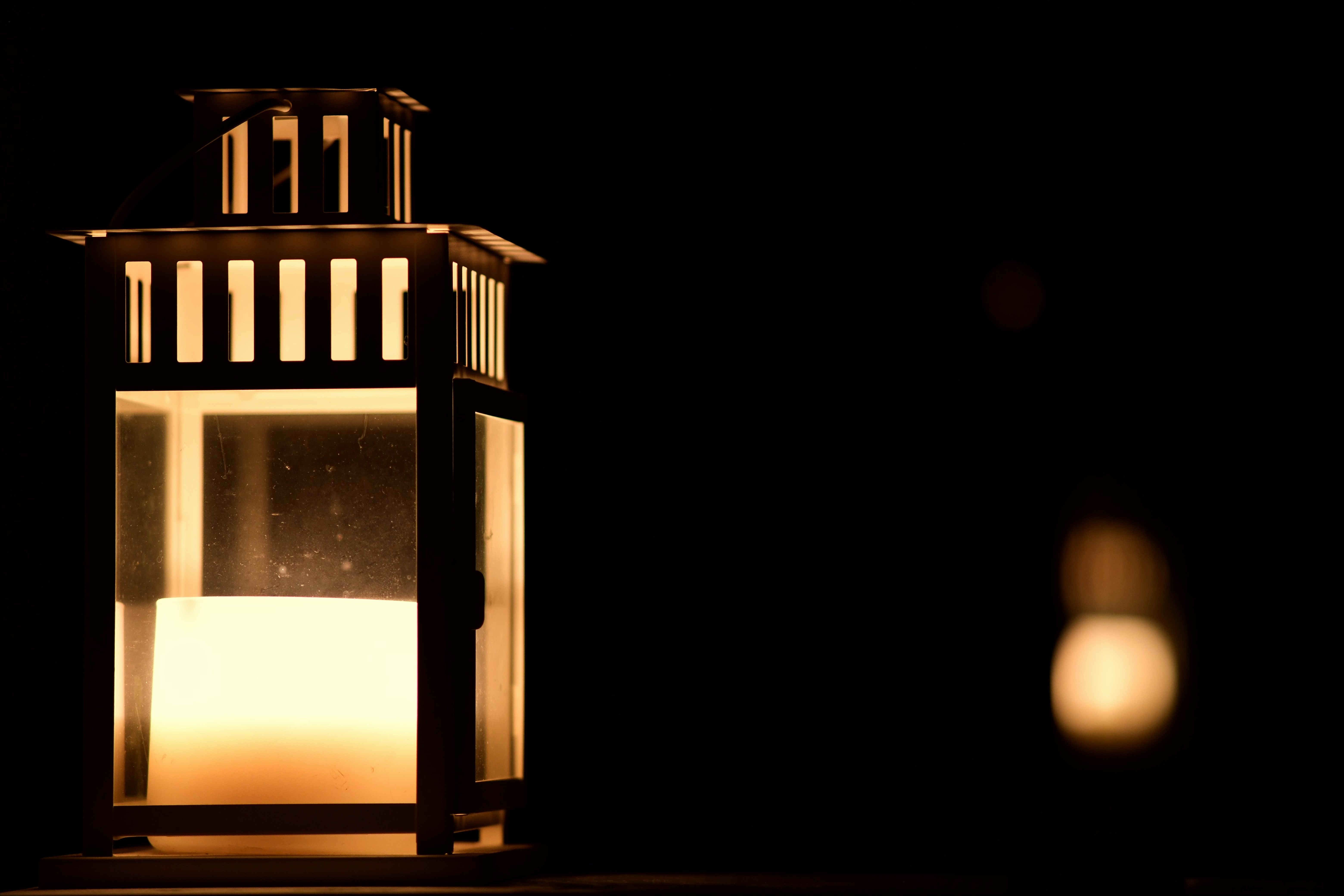 a lantern lit up in the dark with a candle