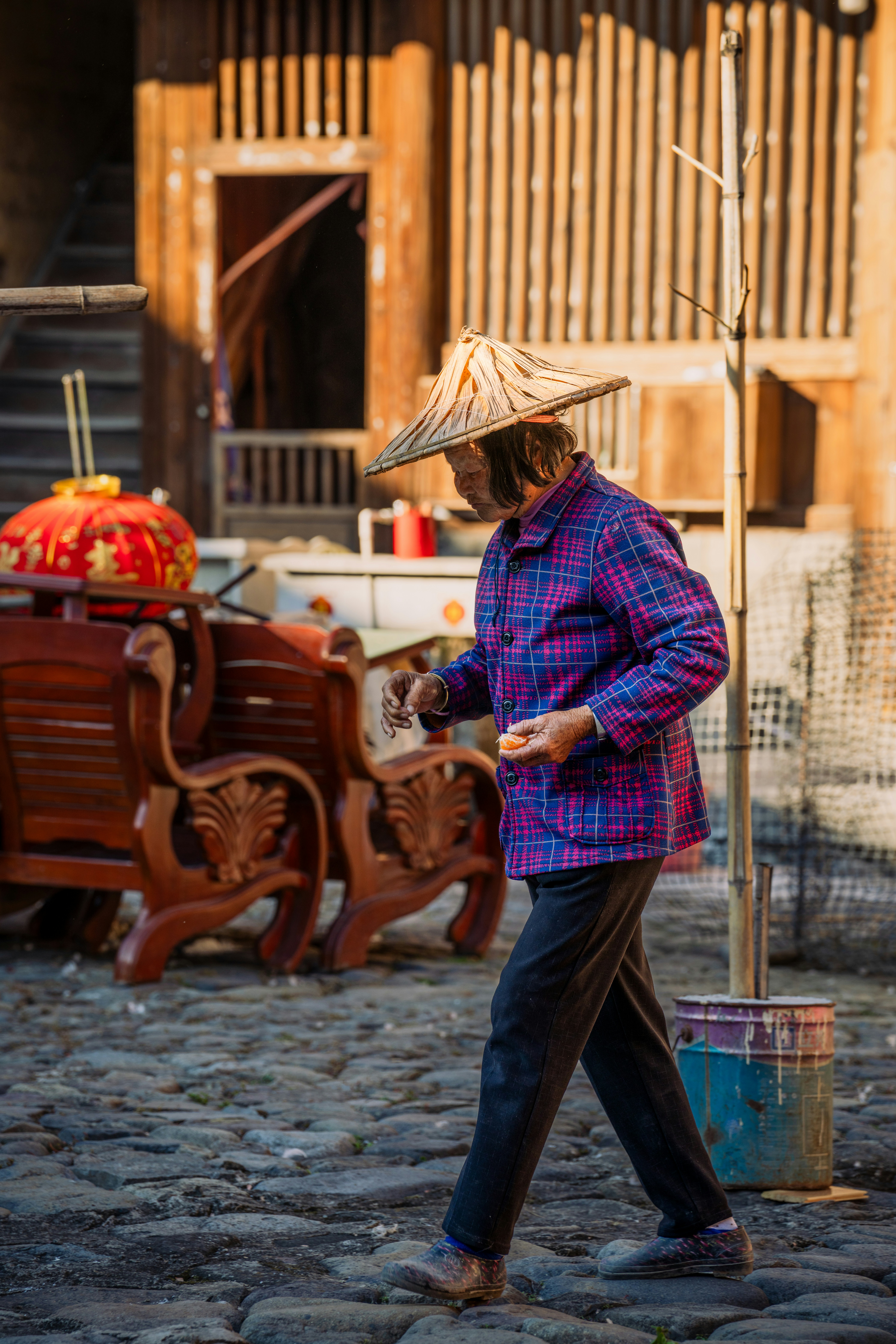 A man with a straw hat walking down a street photo – Free Hekeng earth ...
