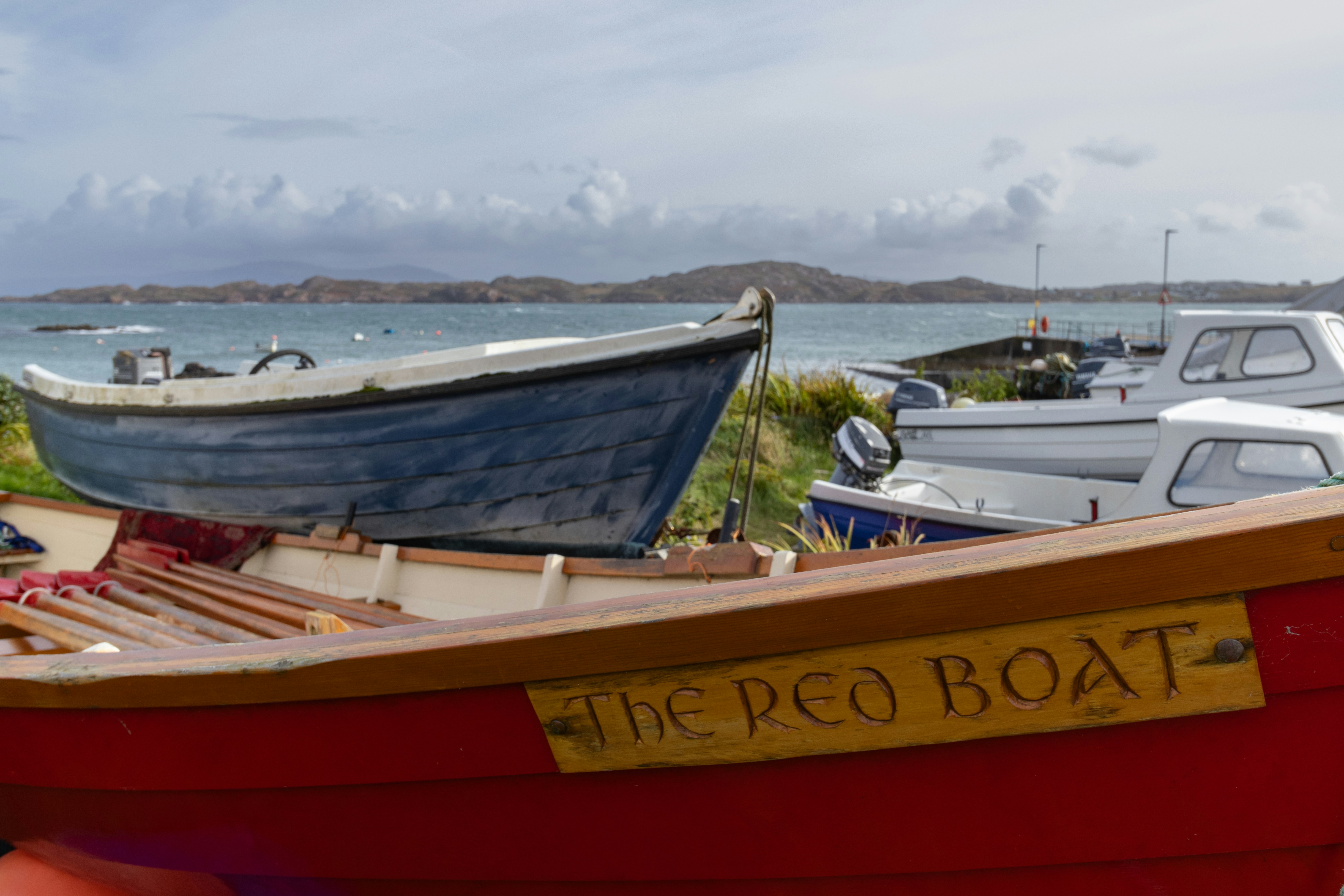 A red boat sitting next to a body of water photo – Free Iona Image on ...