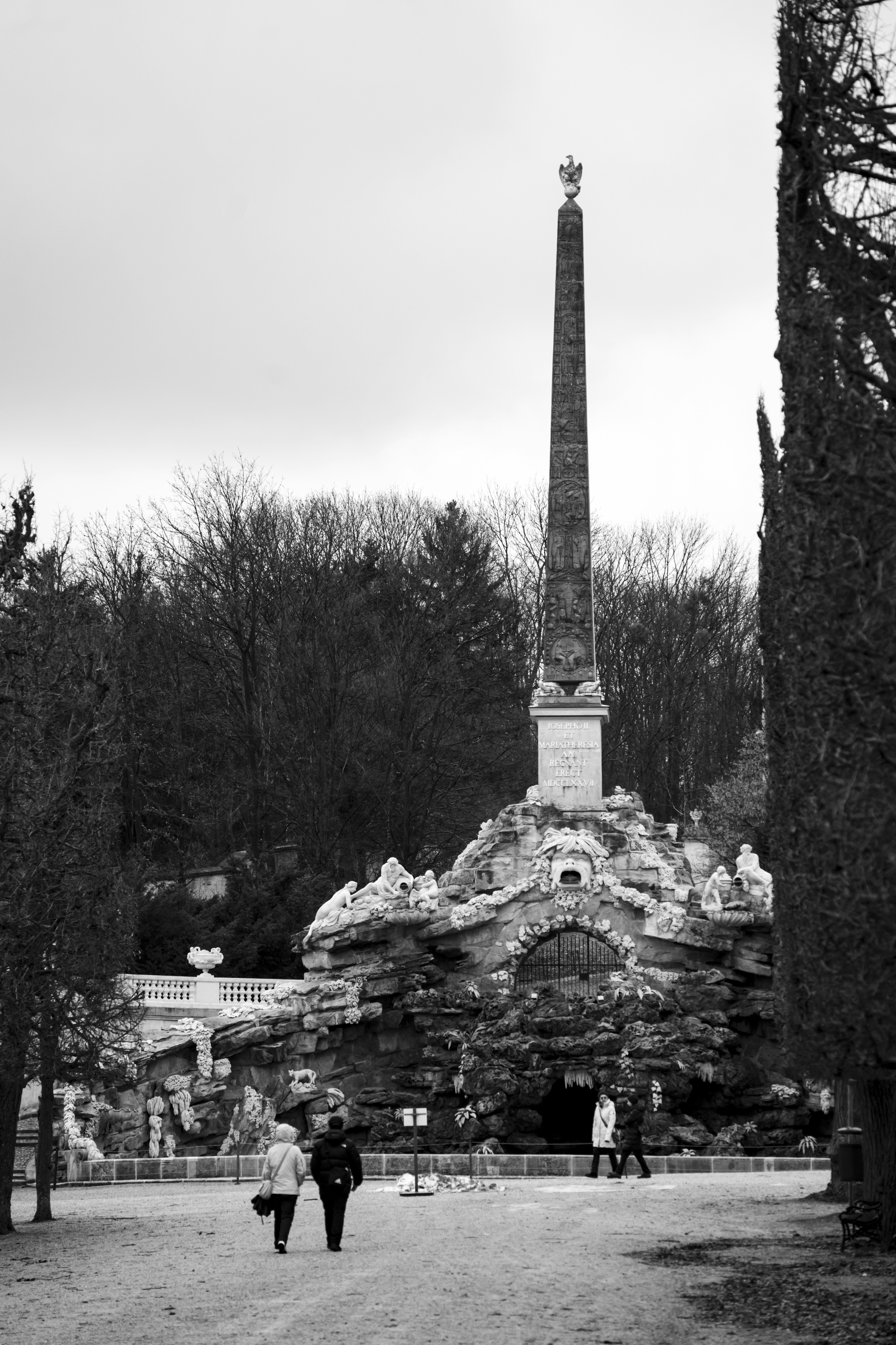 Monumental Obelisk Rising Over Sculpted Garden Ruins