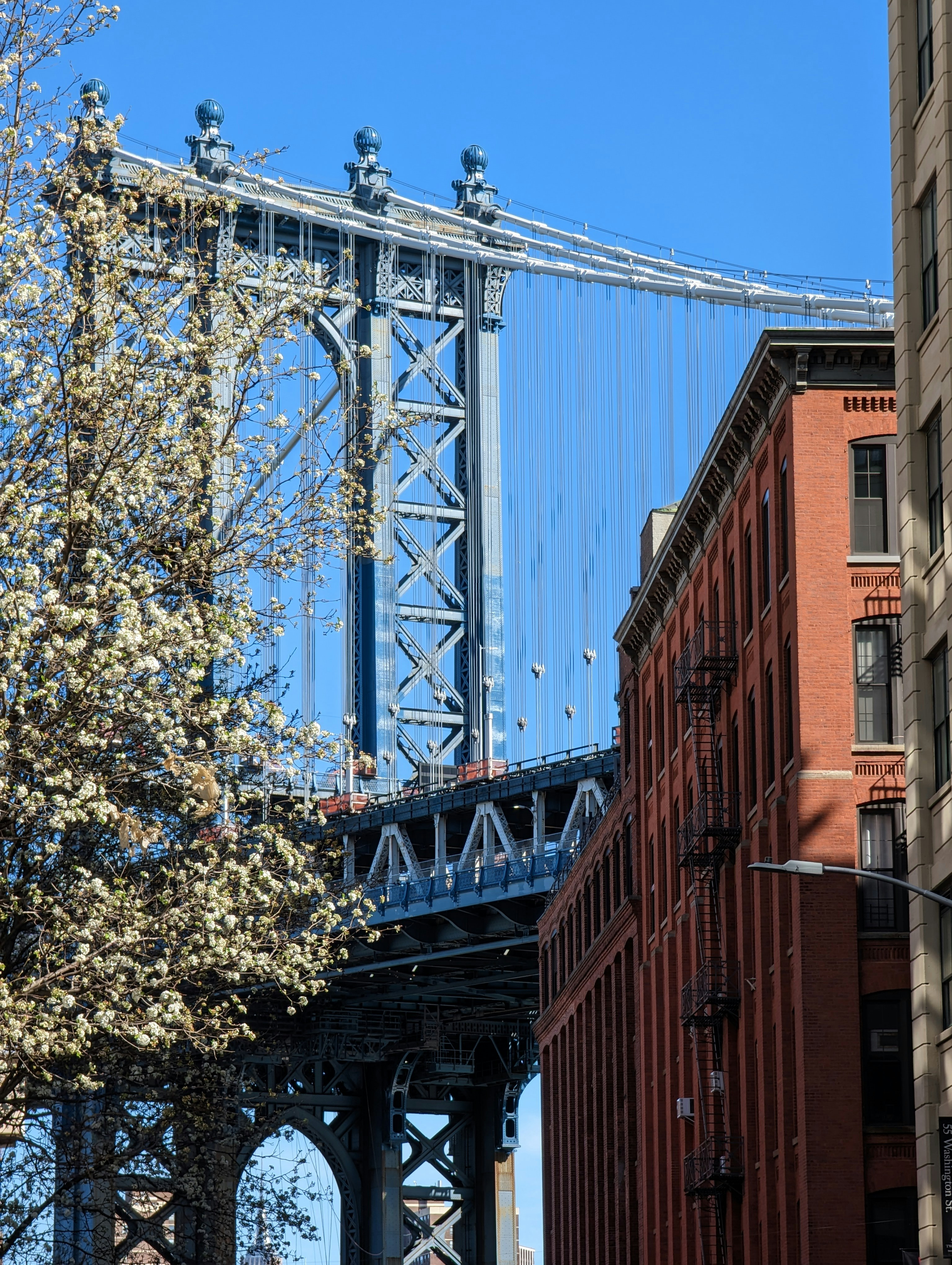 Bridge and Brick Facade Beneath a Spring Sky