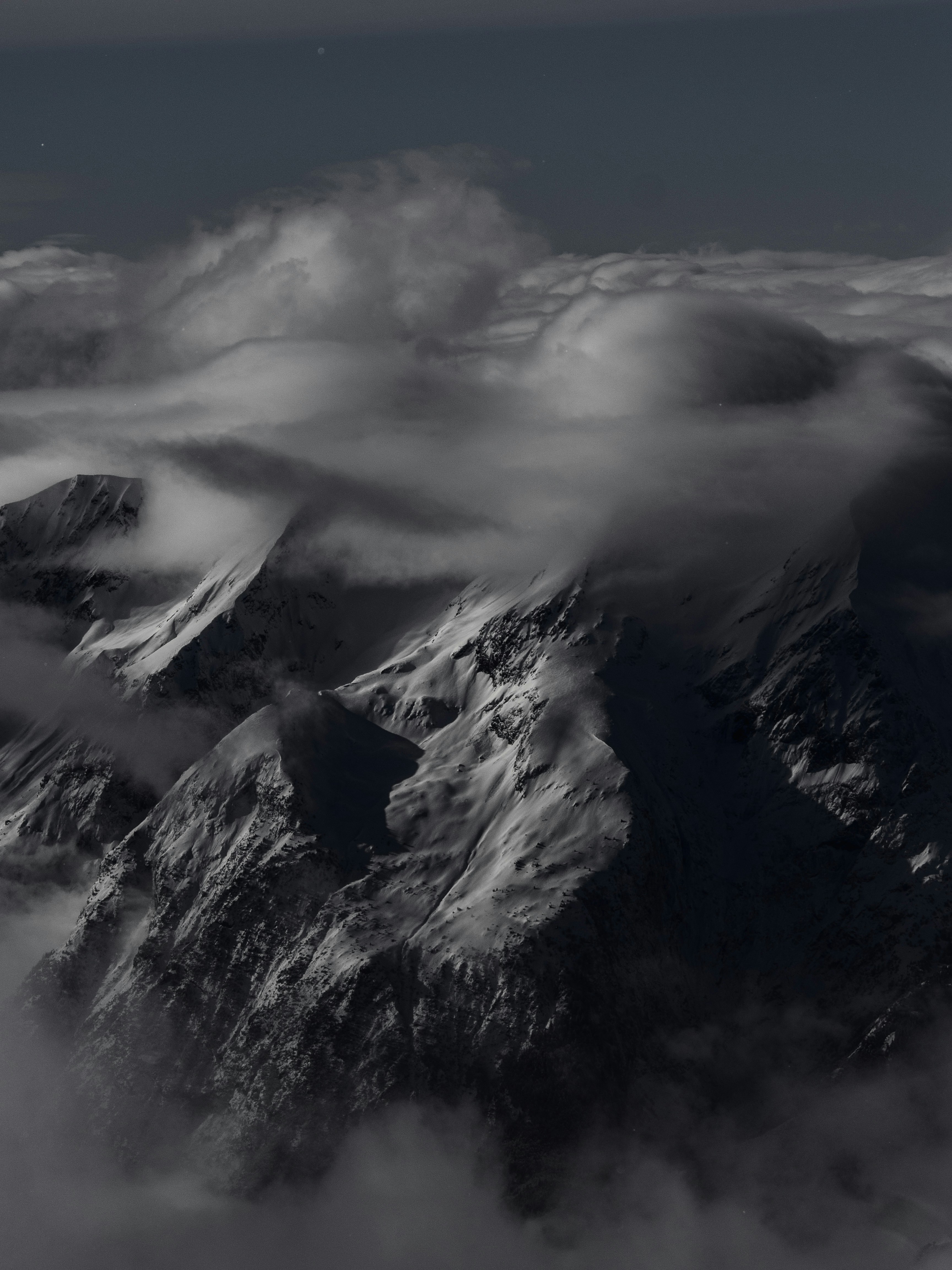 Veiled Giants: The Enigma of Snow-Capped Peaks