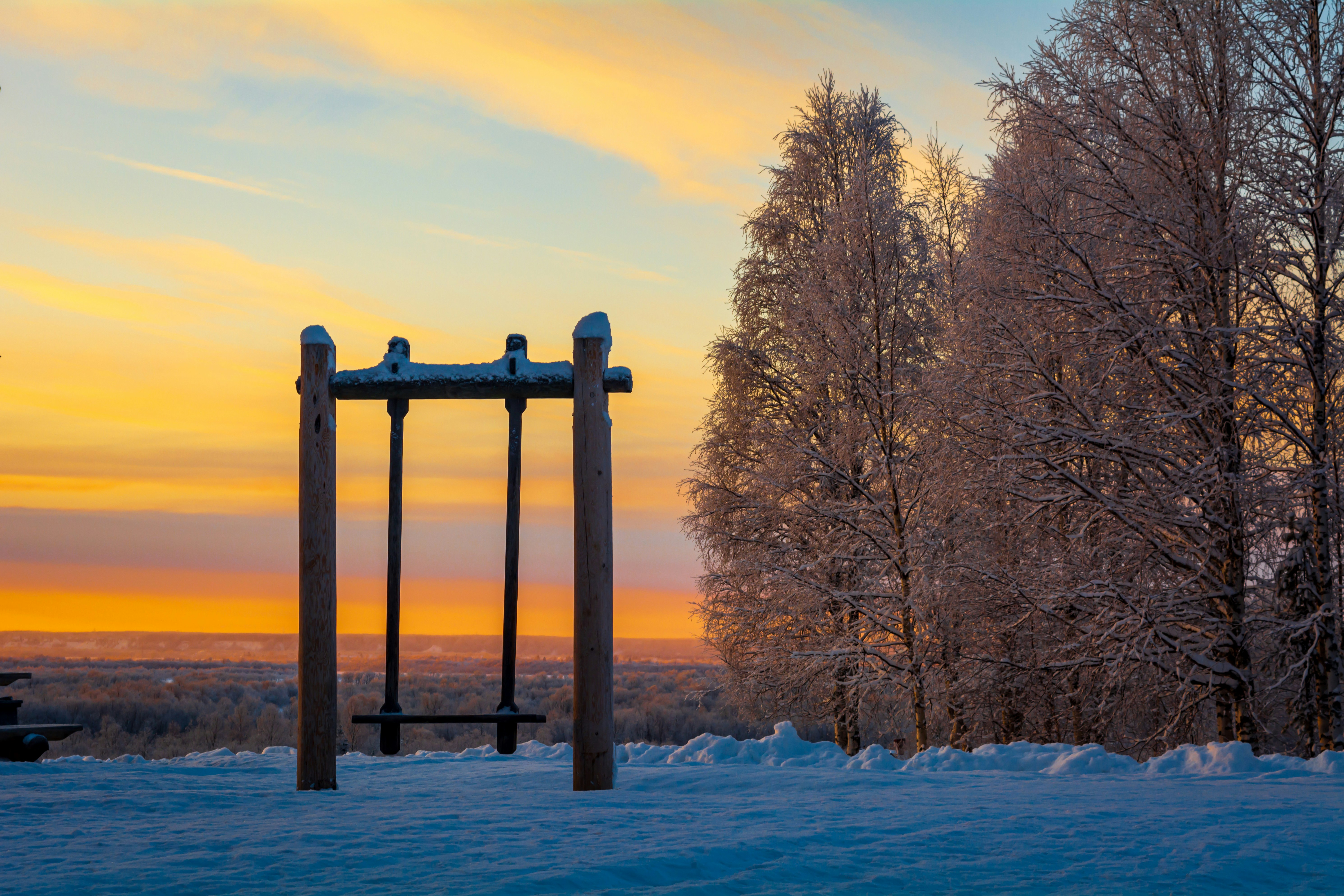 Una panchina seduta in mezzo a un campo innevato foto – Immagine gratis ...