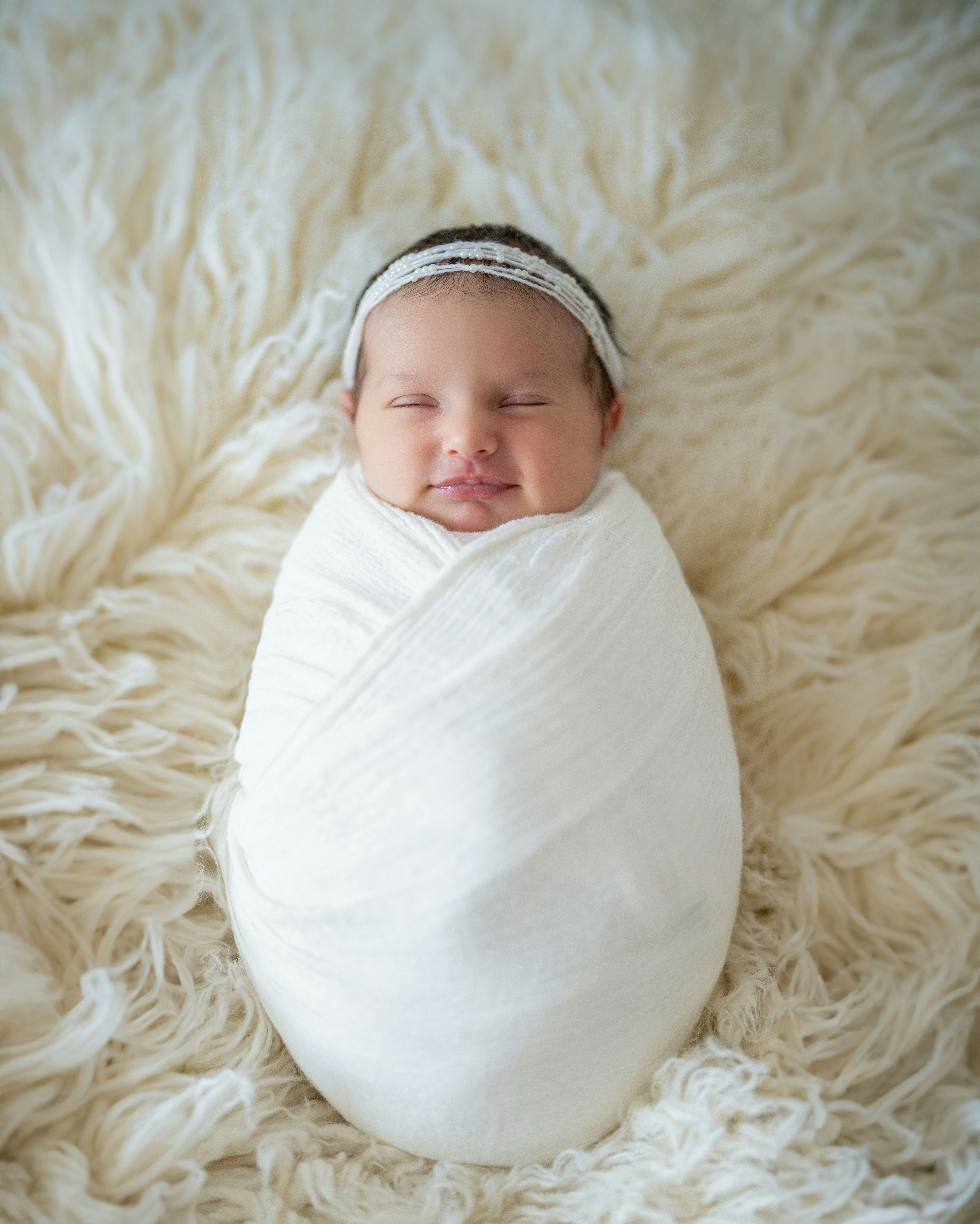 A newborn baby wrapped in a white blanket photo – Free Newborn Image on ...