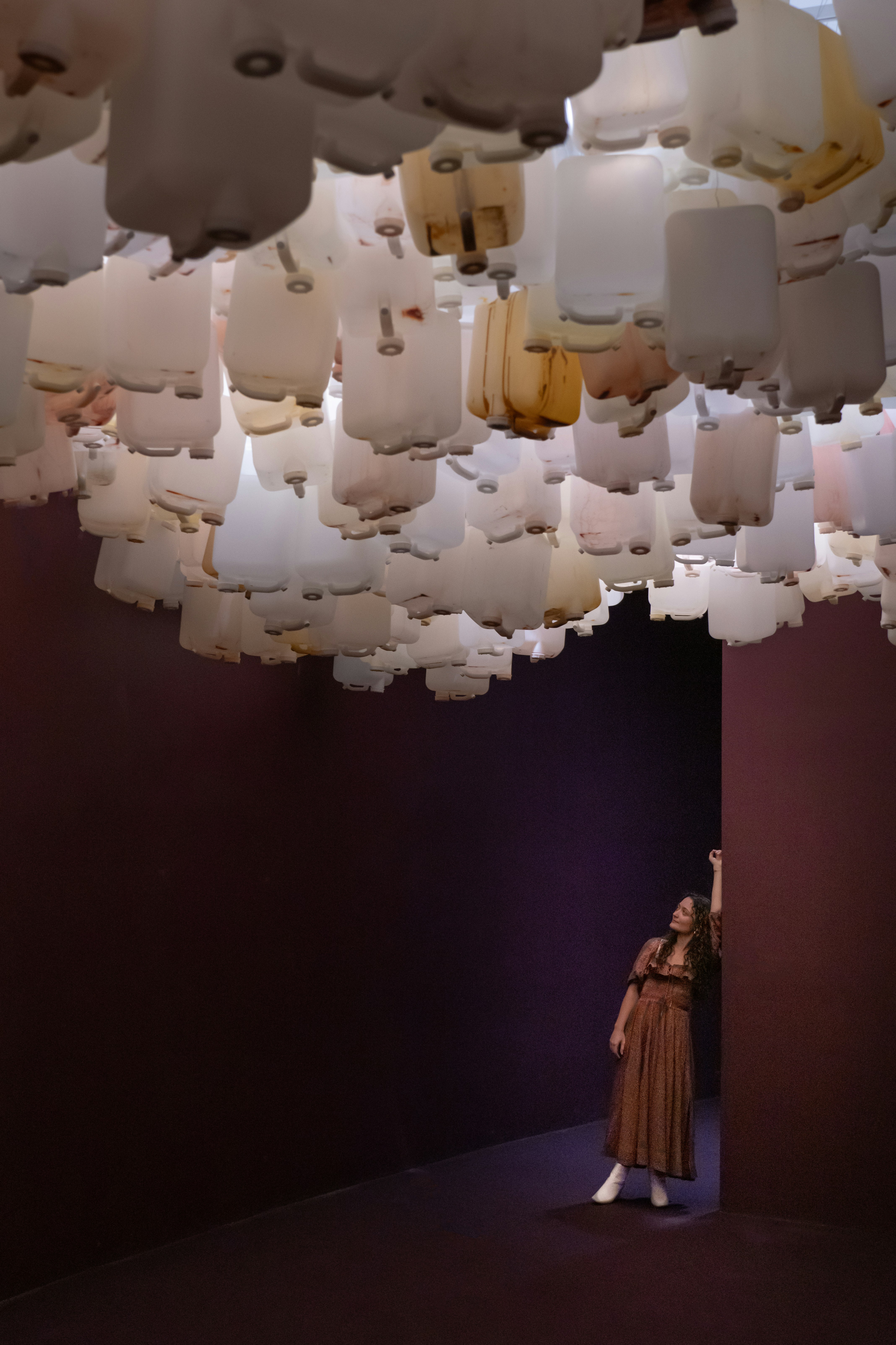 Amber Canopy: A Woman Beneath a Ceiling of Glass Lanterns