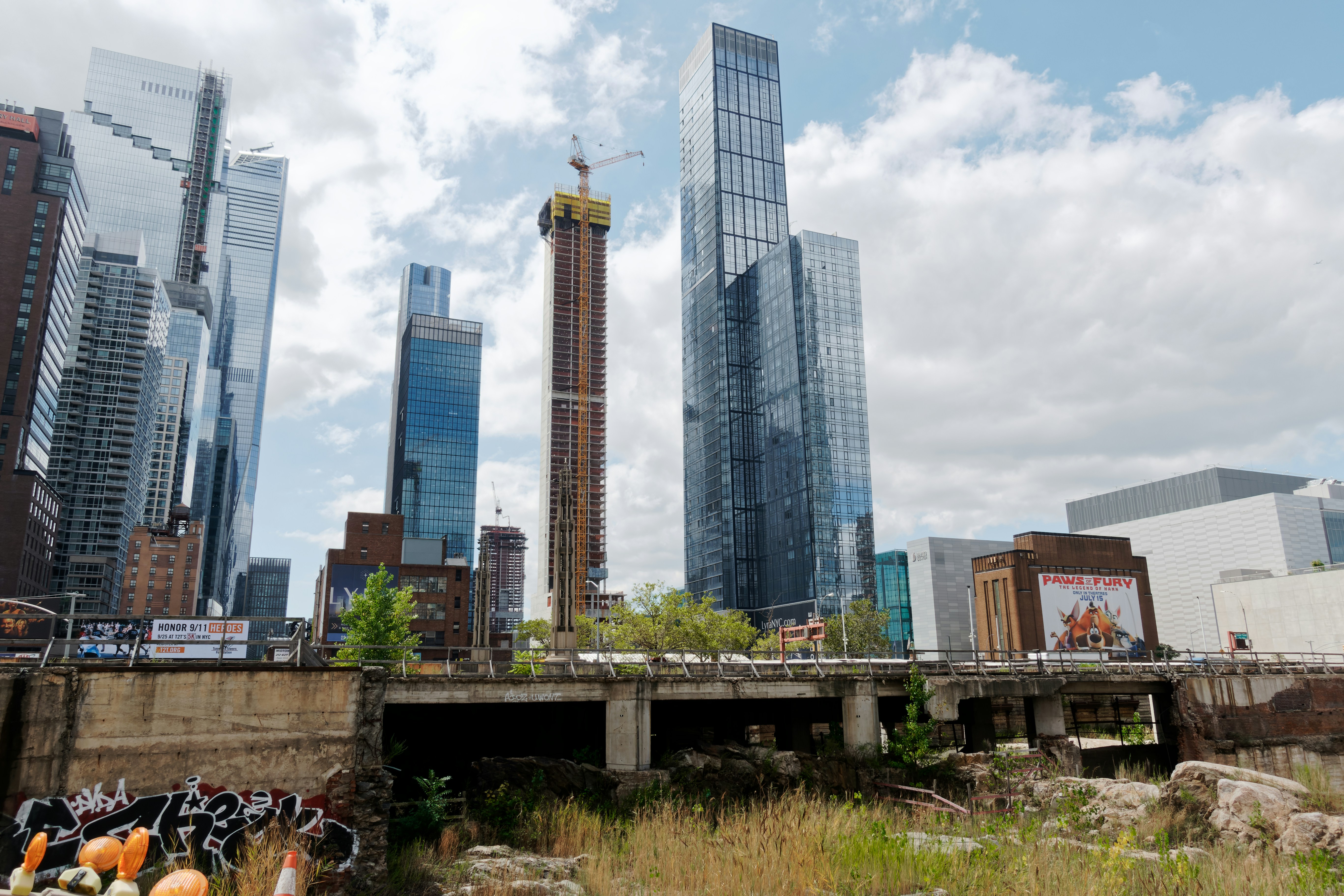 Urban Echoes: Concrete Giants Rise Over an Arid Waterfront