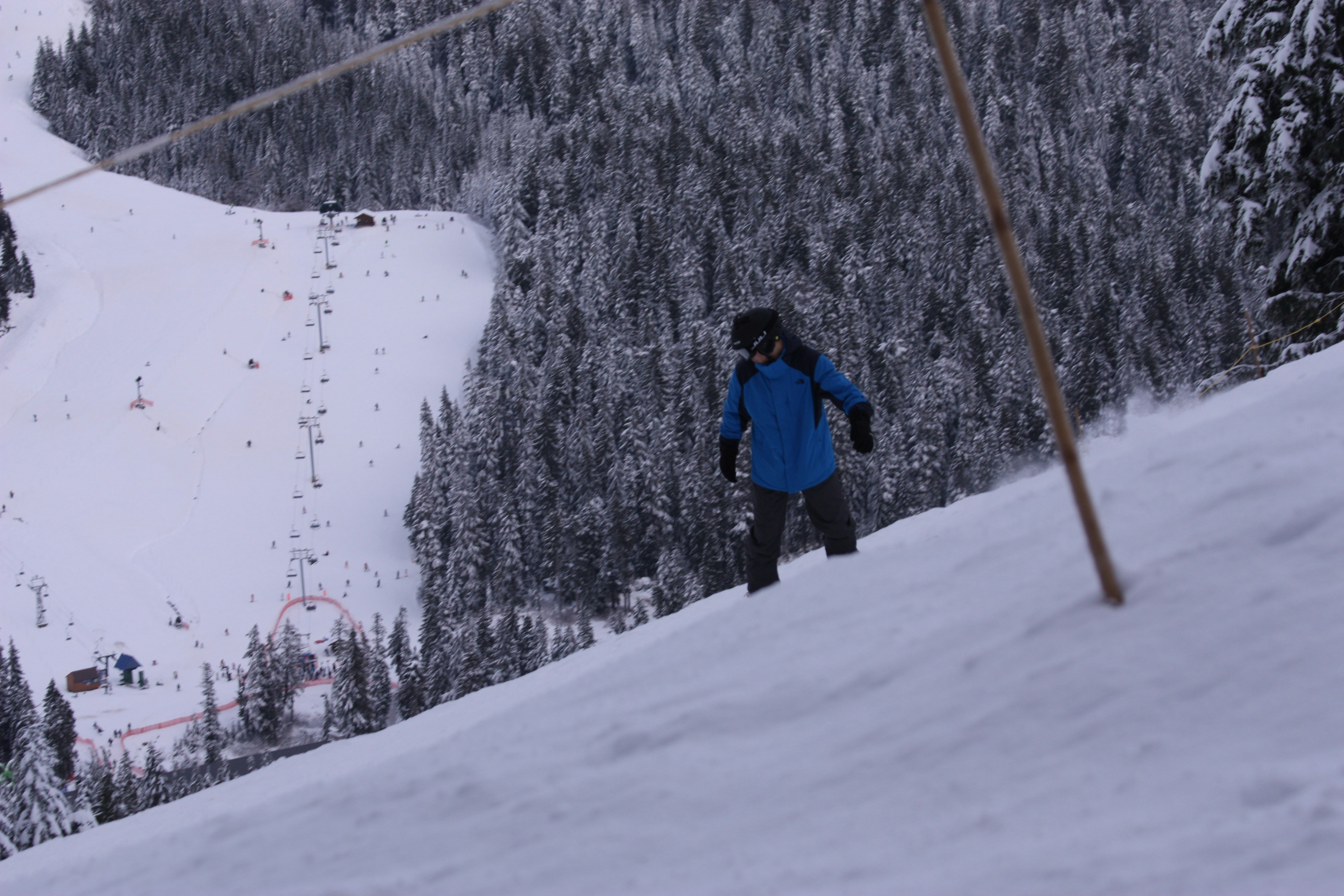 A person standing on a snow covered ski slope photo – Free Man Image on ...