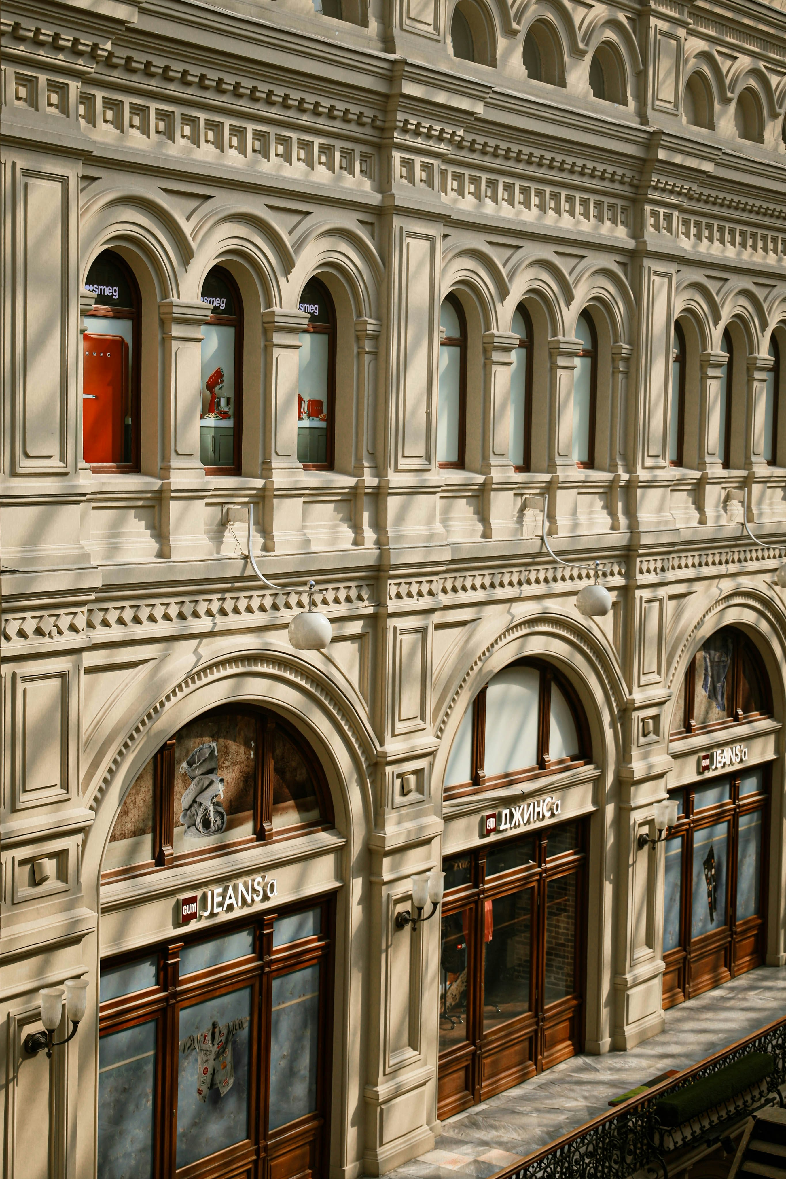Arched Rhythm Along a Sunlit Urban Façade