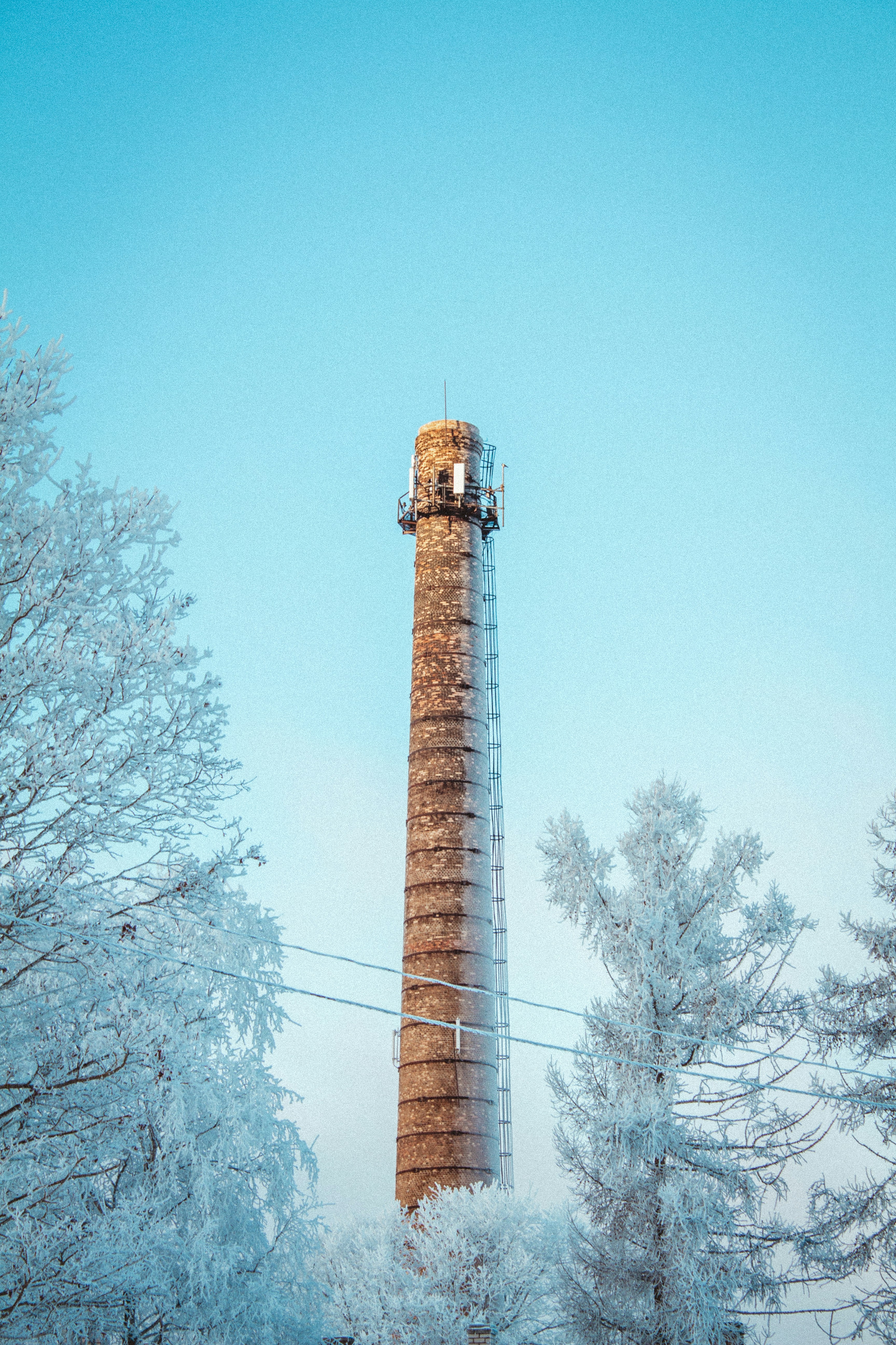 Frost-Kissed Brick Chimney Reaching Into a Cerulean Winter Sky