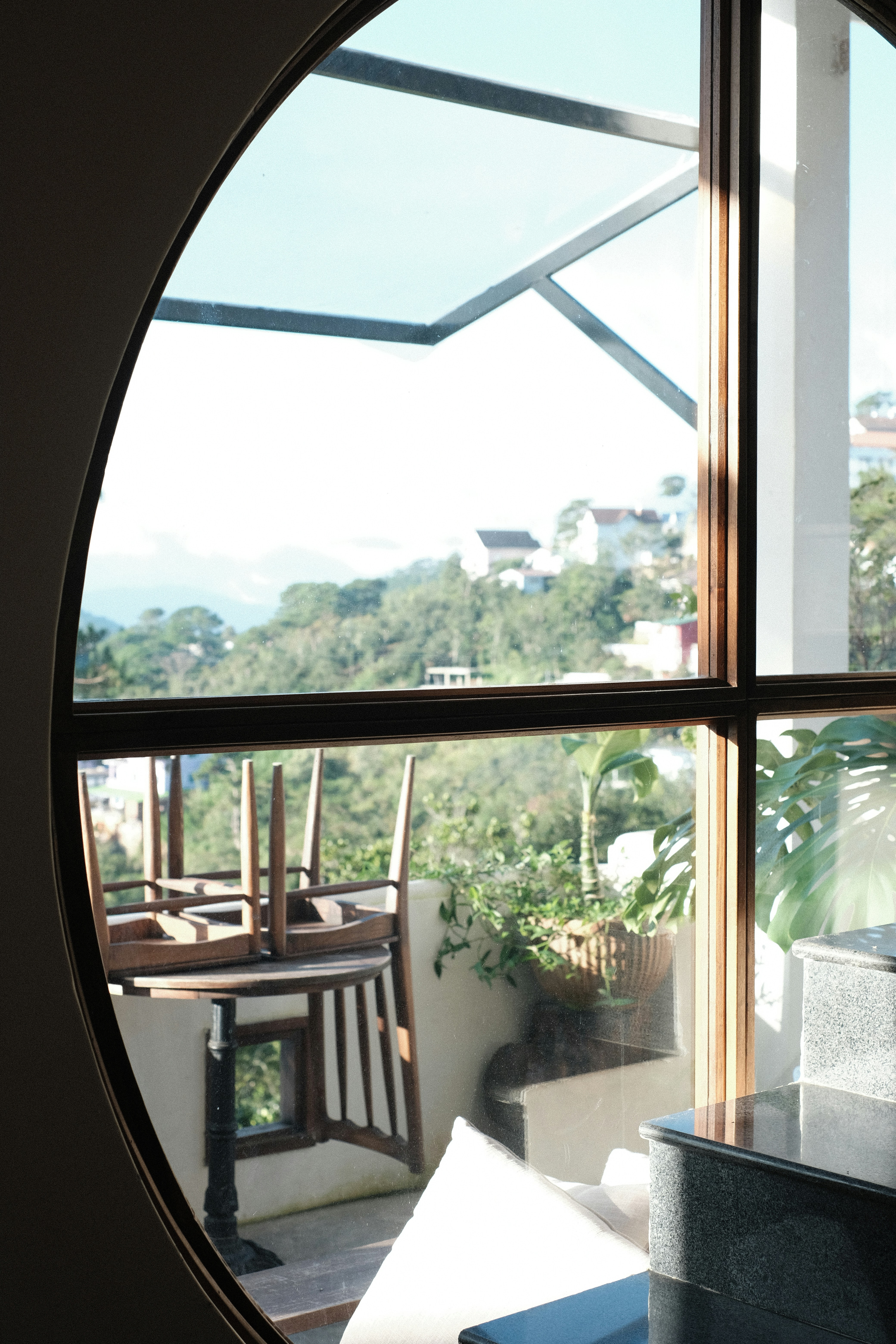 Circular Window, Quiet Balcony, Distant Hillside Village