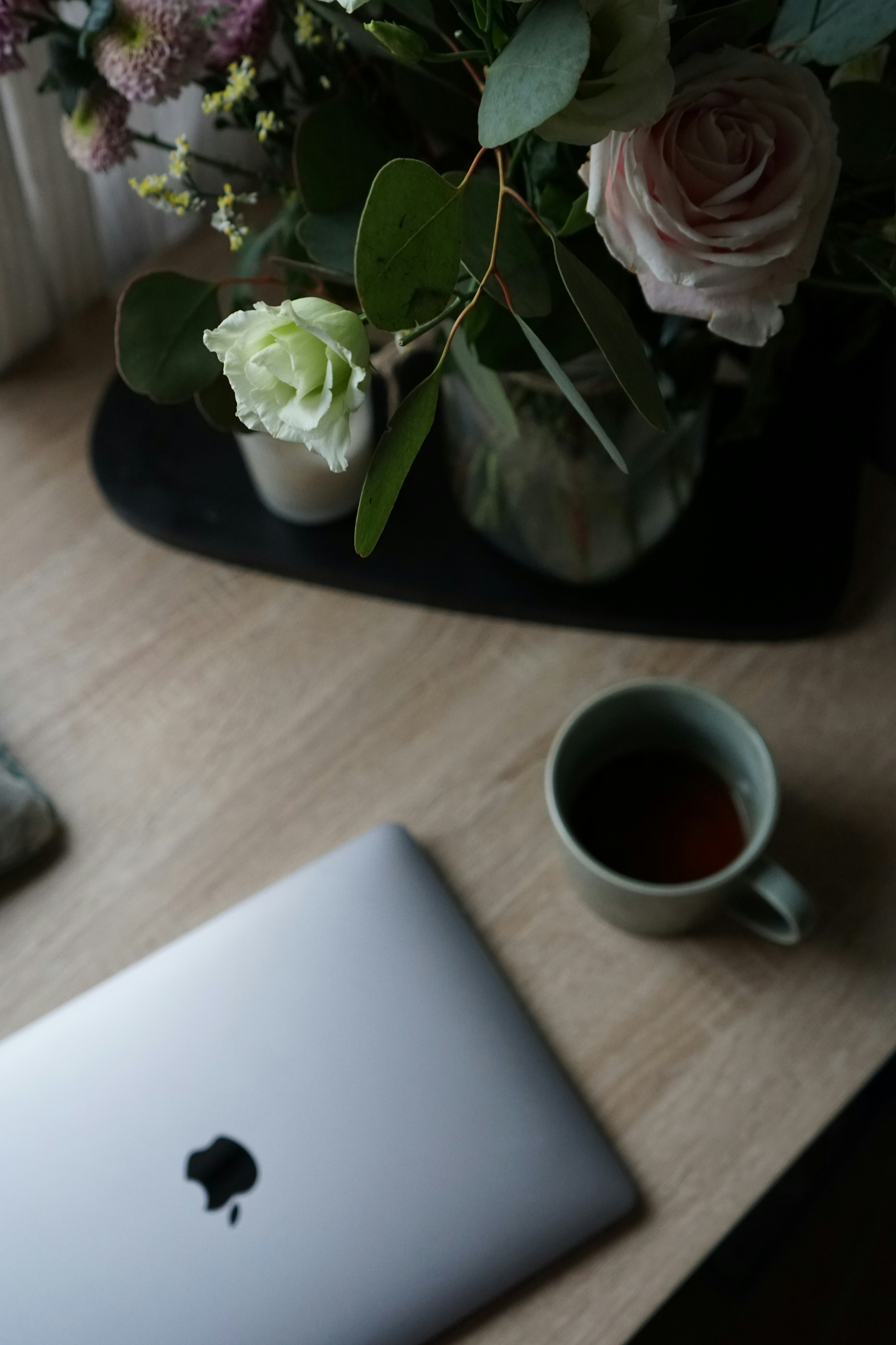 Laptop, coffee and a bouquet of flowers