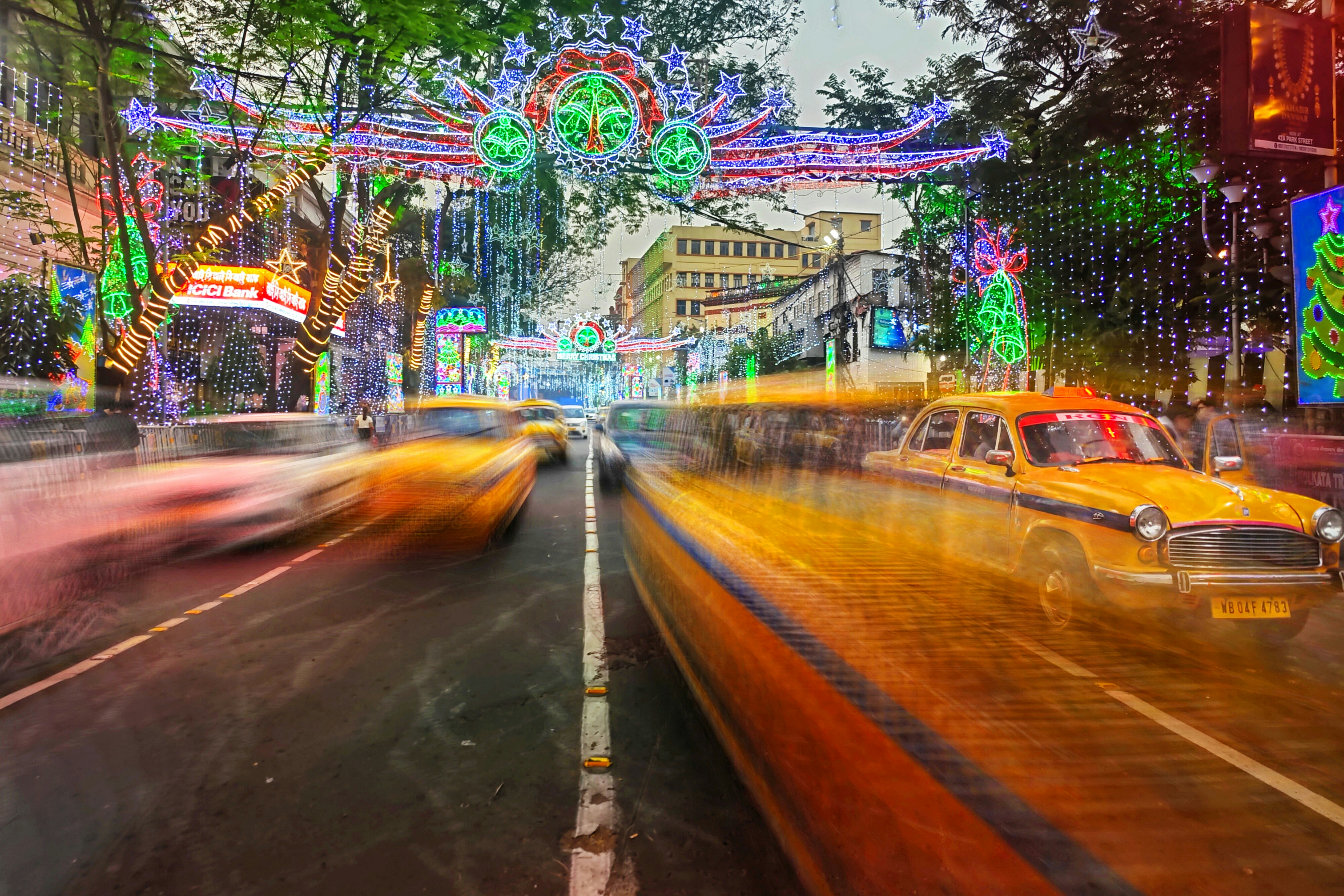 Neon Boulevard: Long-Exposure Motion on a Festive Urban Street