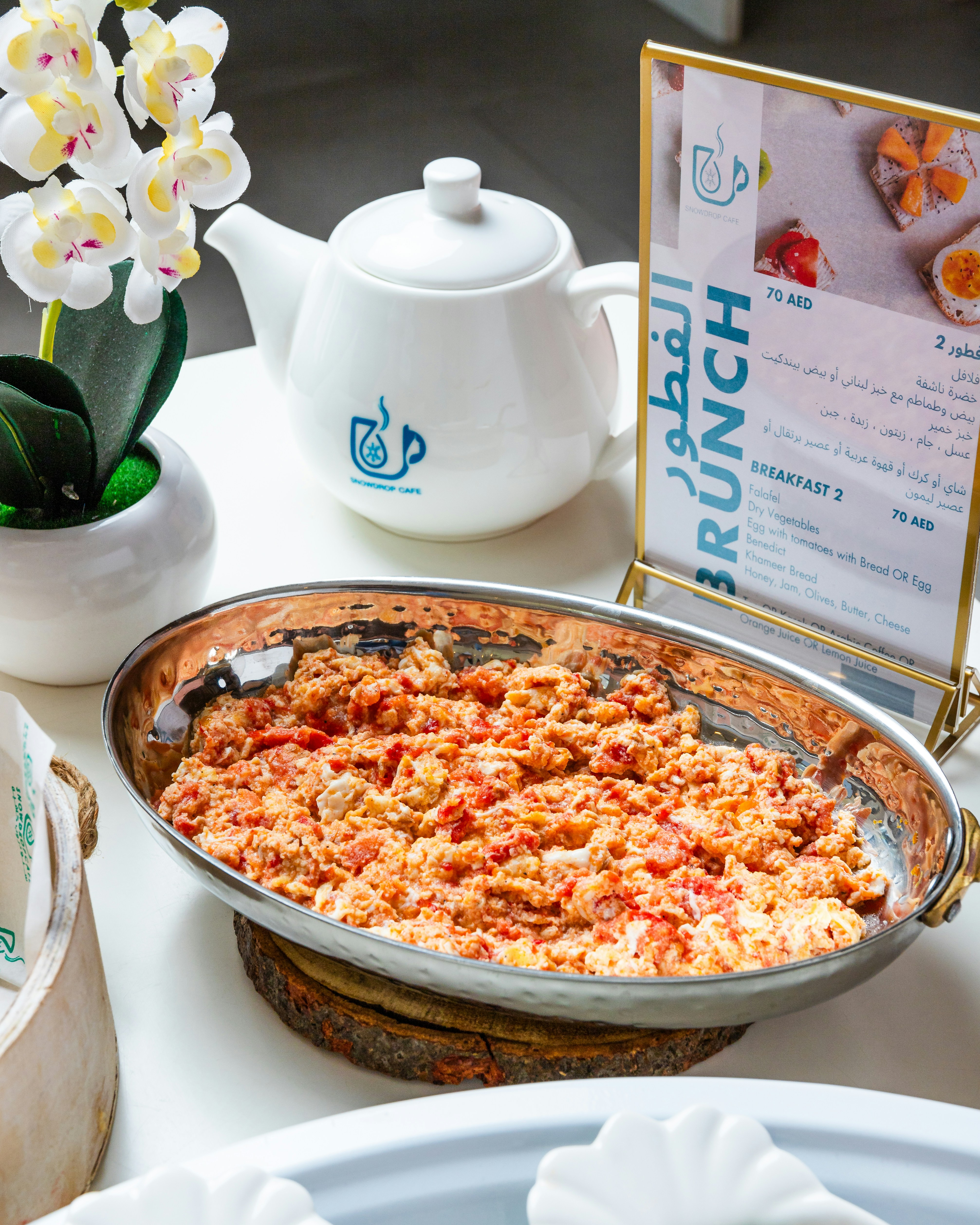 Culinary Brunch Mosaic: Baked Dish with Teapot and Orchid Accent