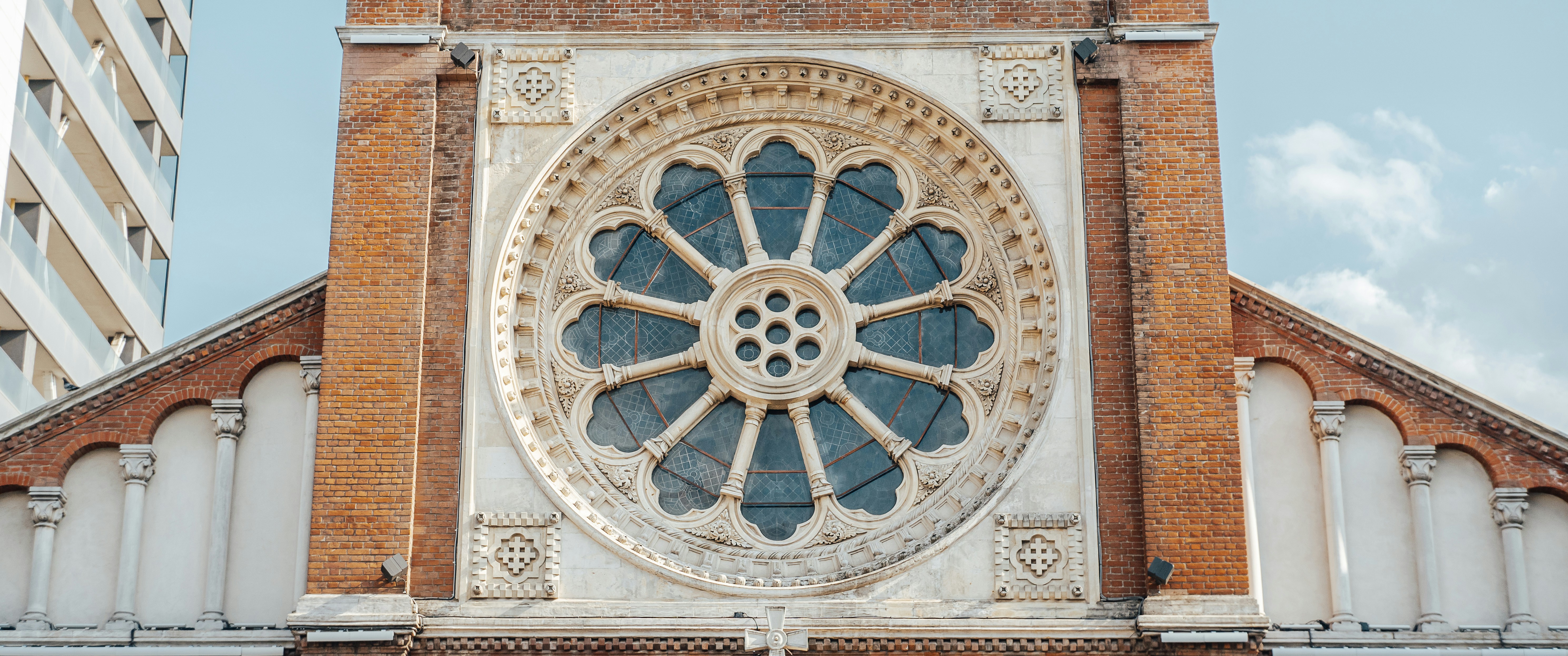 Rosette in Red Brick: Circular Window Framing a City Facade