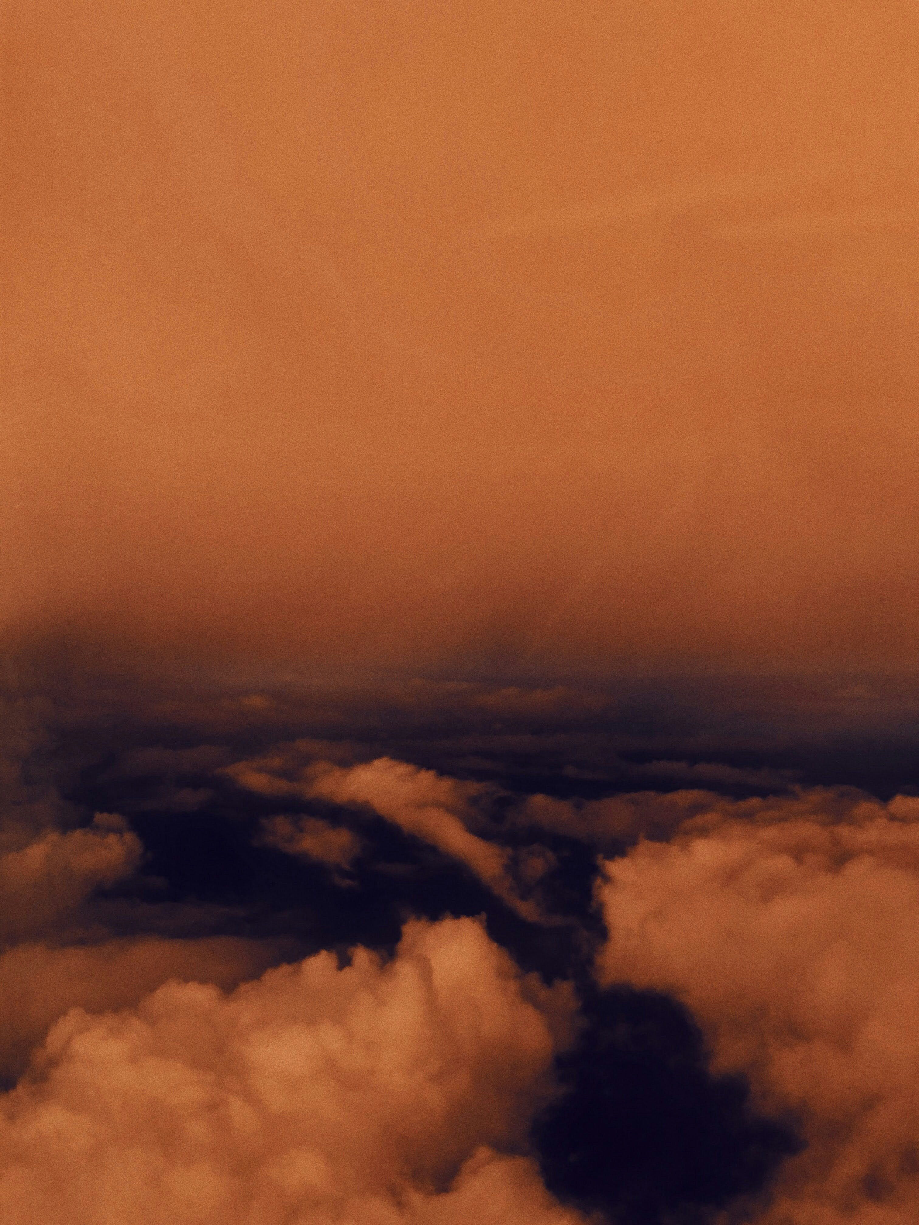 Amber Horizon Over a Sea of Clouds: An Aerial Sunset Portrait