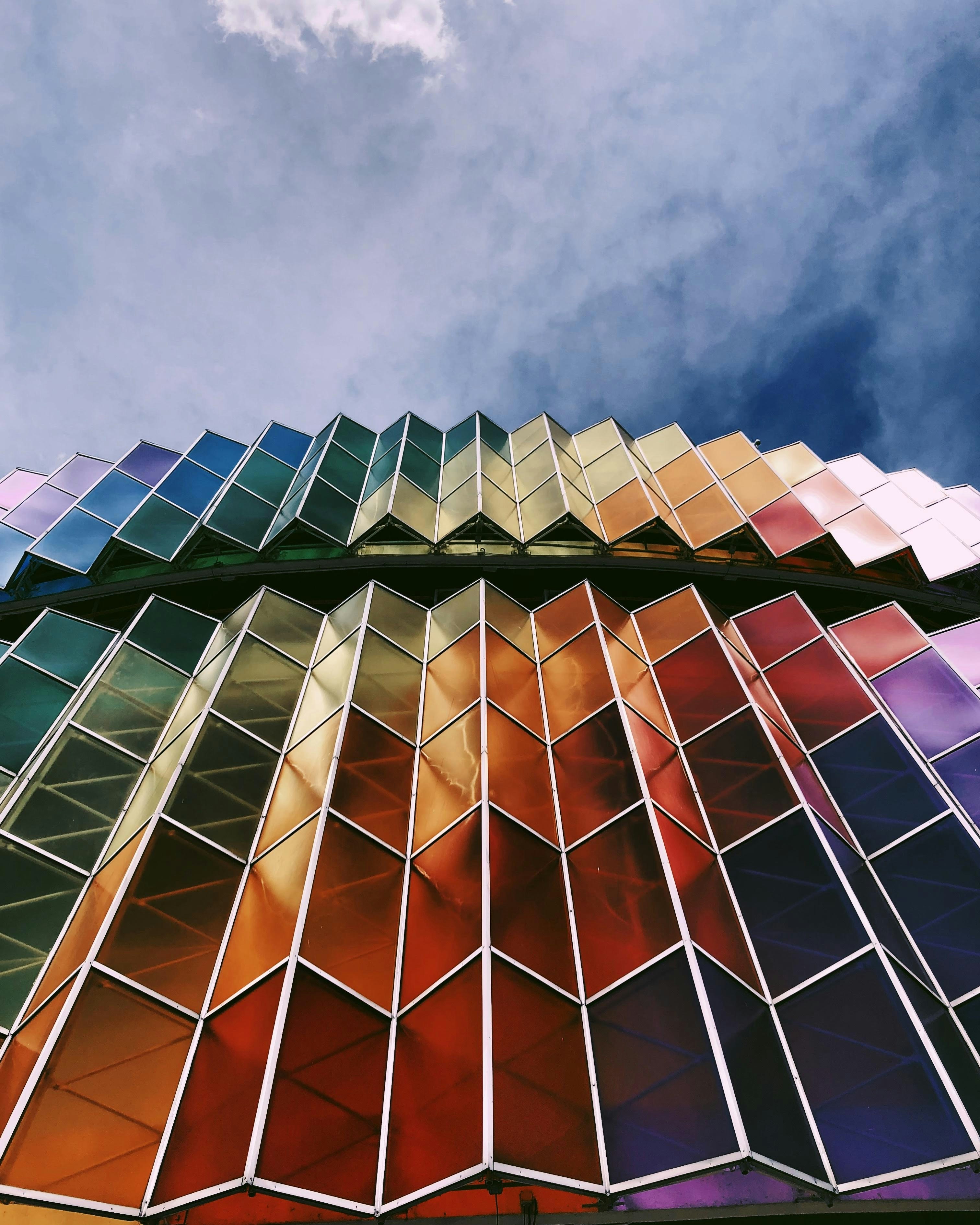 Prismatic Chevron: Rainbow Glass Façade Reaching Skyward