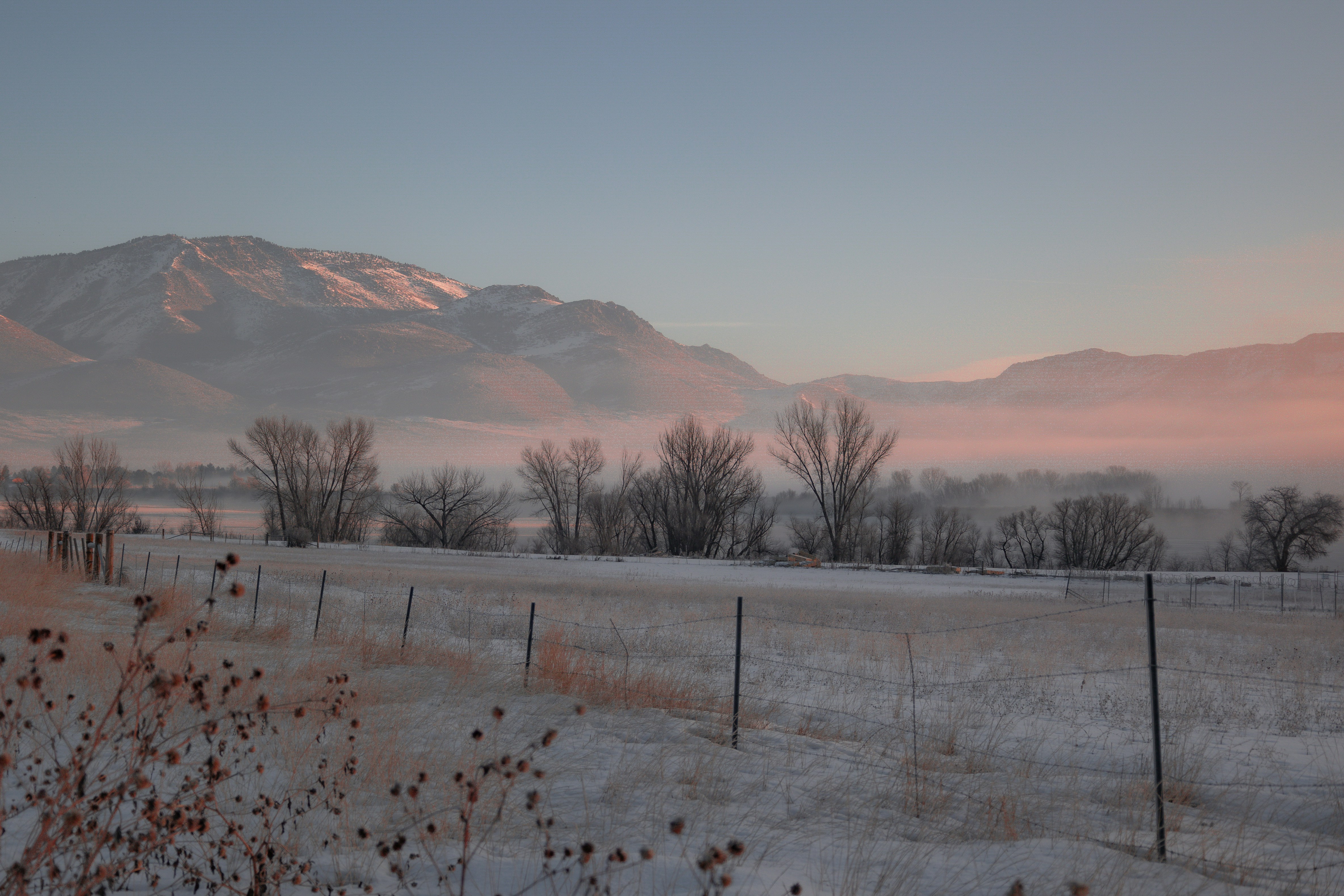 Misty Valley Sunrise Over Snow-Capped Range