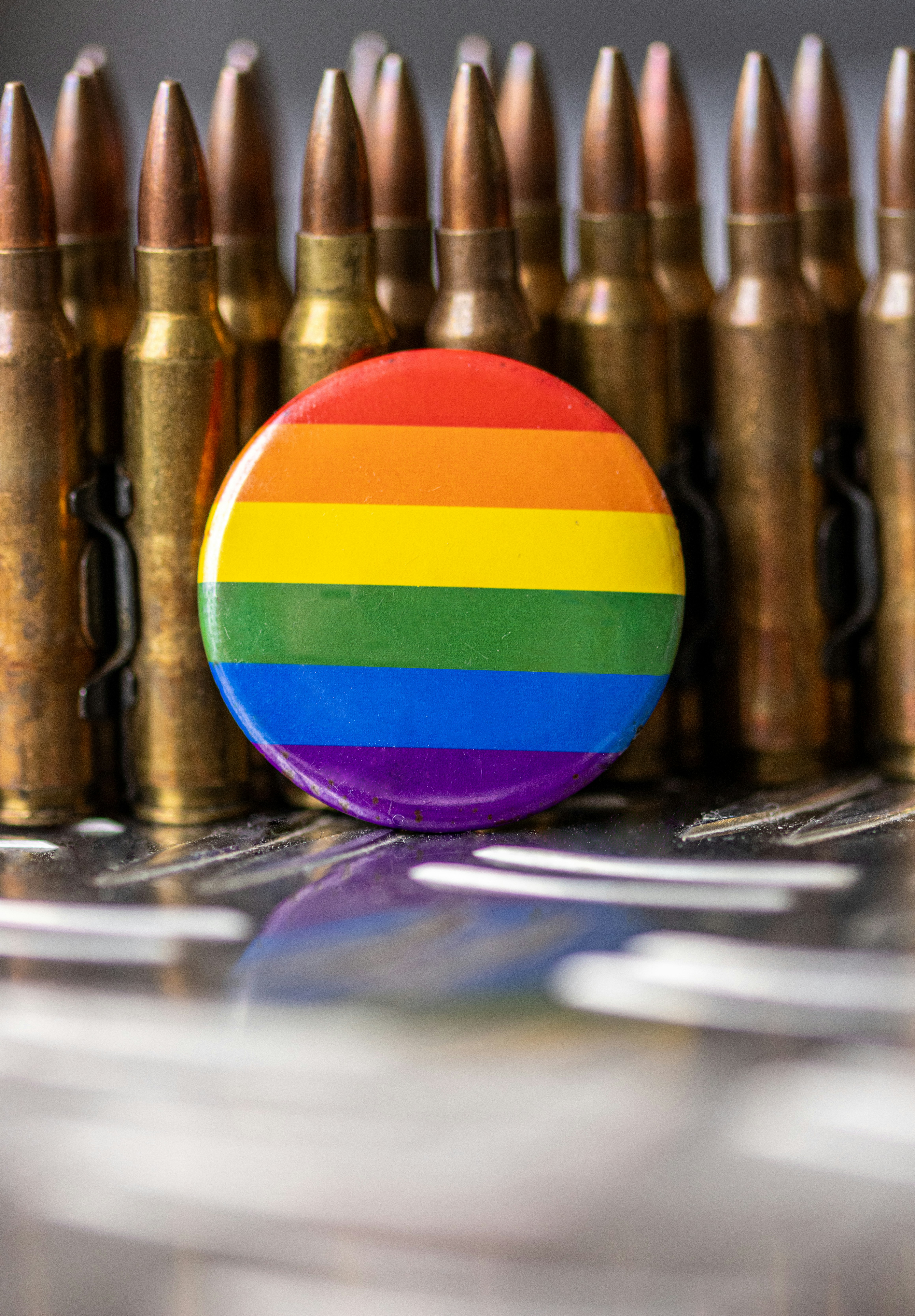 Prismatic Pride Pin Surrounded by Brass Cartridges