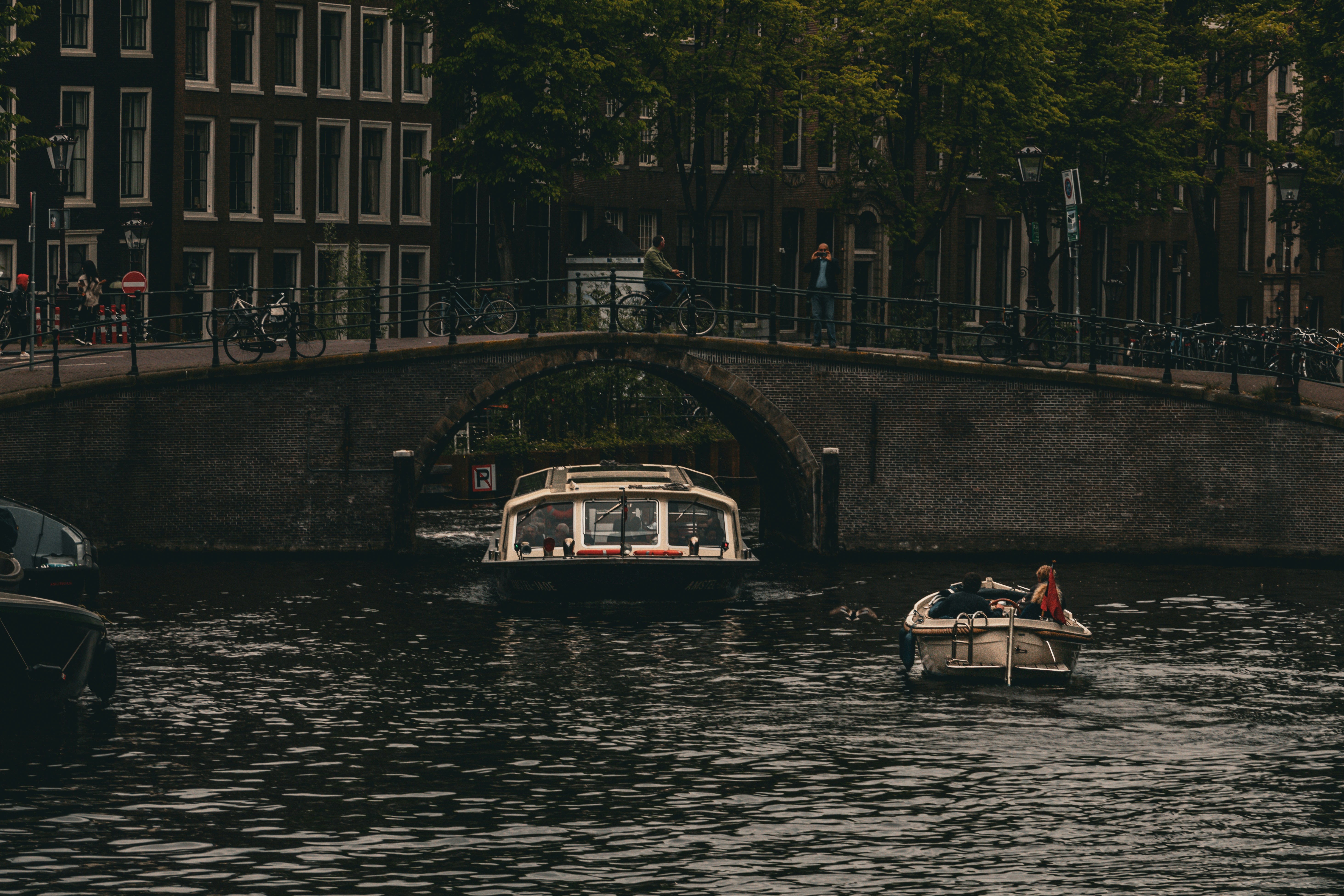Dusk on the Canal: Quiet Drift Beneath a Brick-Arch Bridge