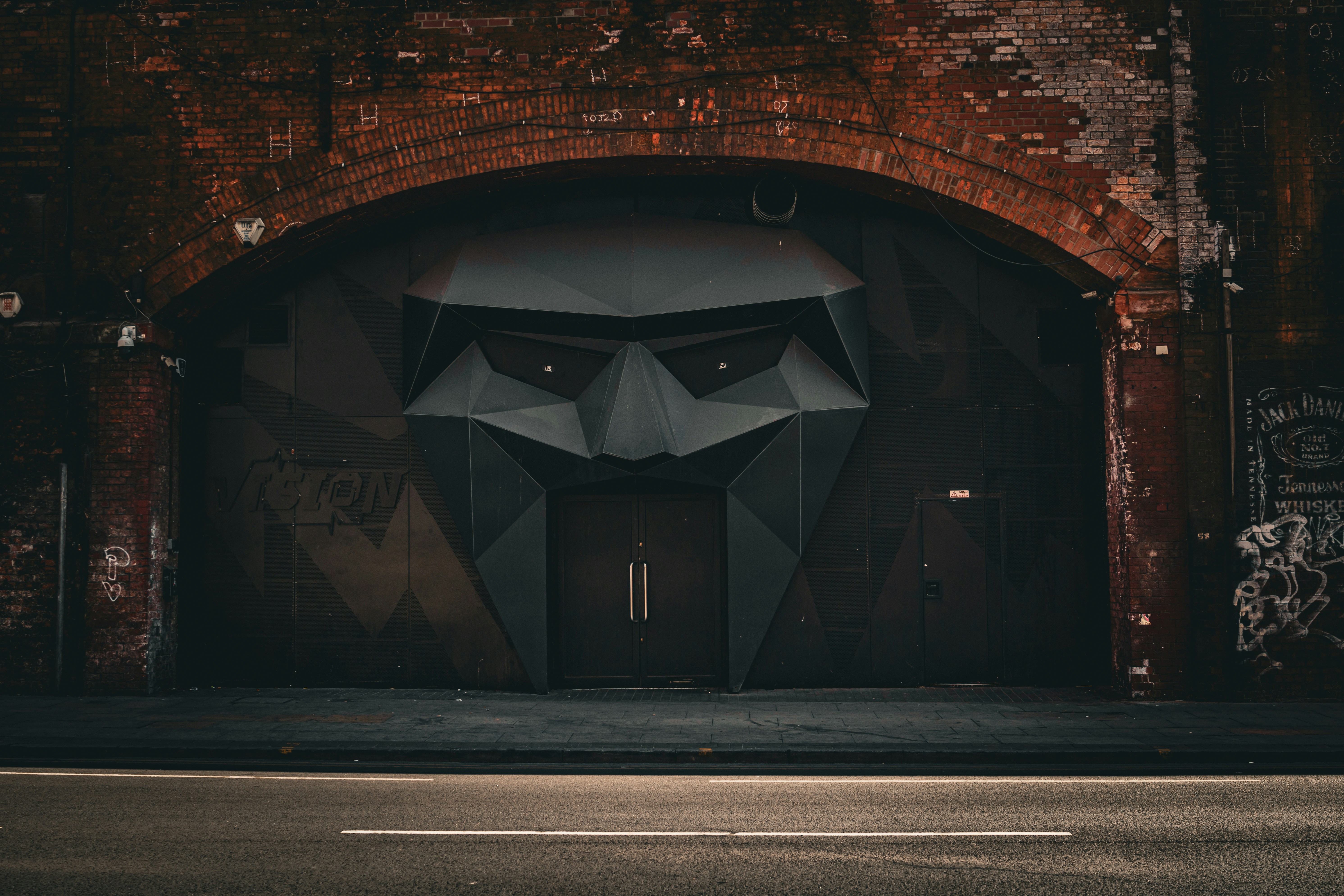 A building with a face on the side of it photo – Free Building Image on ...