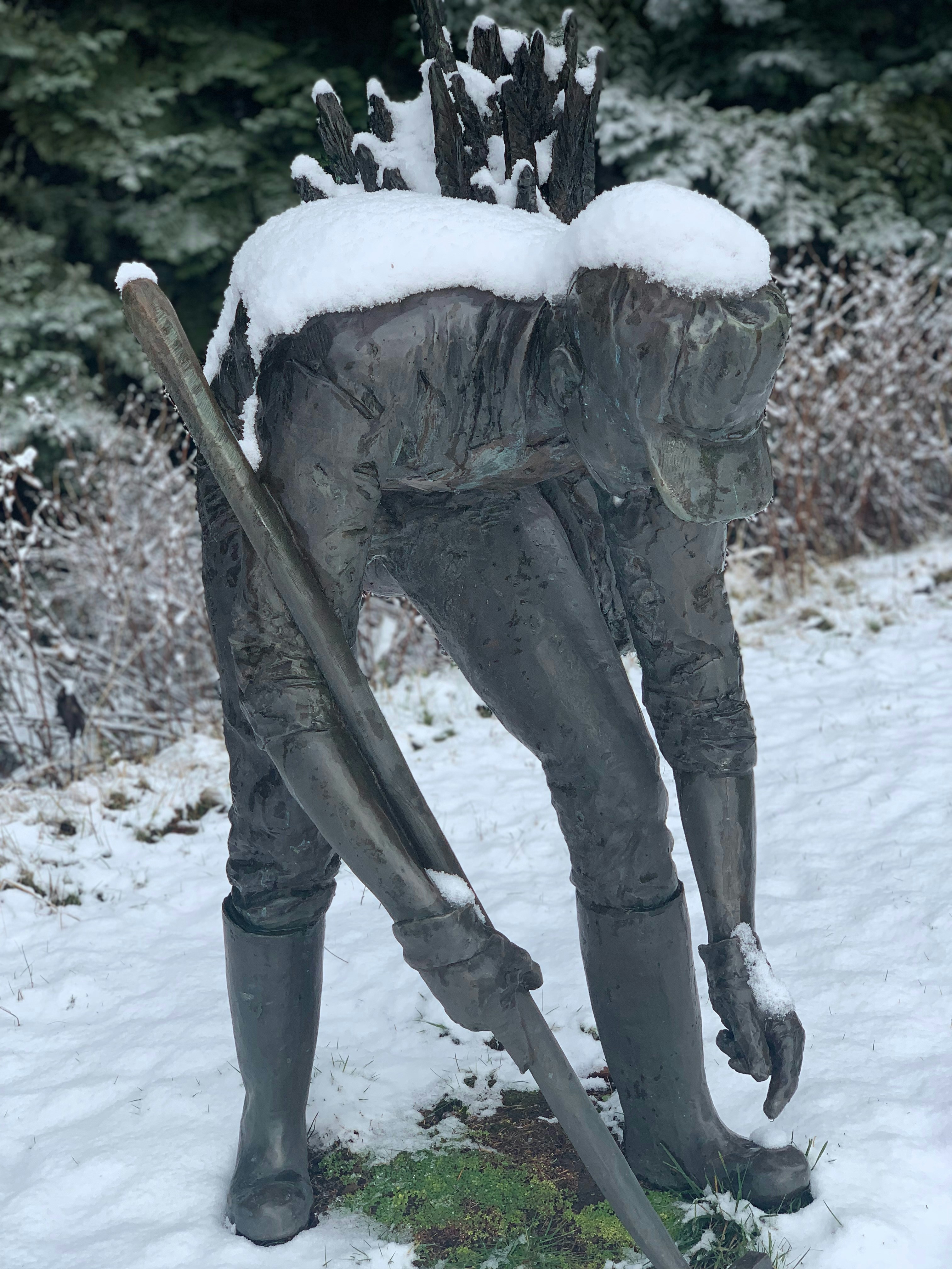 A statue of a man holding a baseball bat in the snow photo – Free Art ...