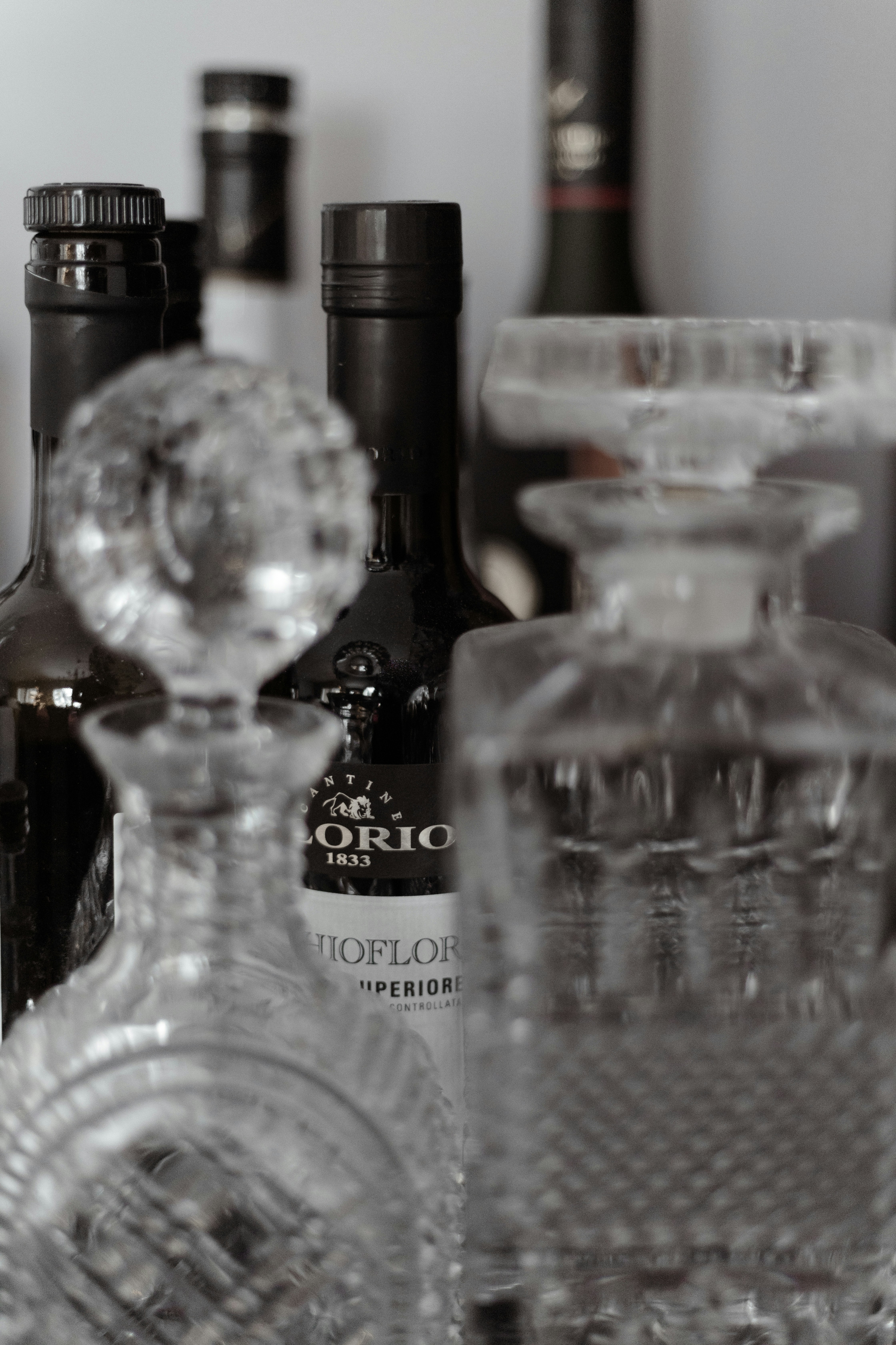 Glass and Echoes: A Monochrome Still Life of Bottles and Crystal