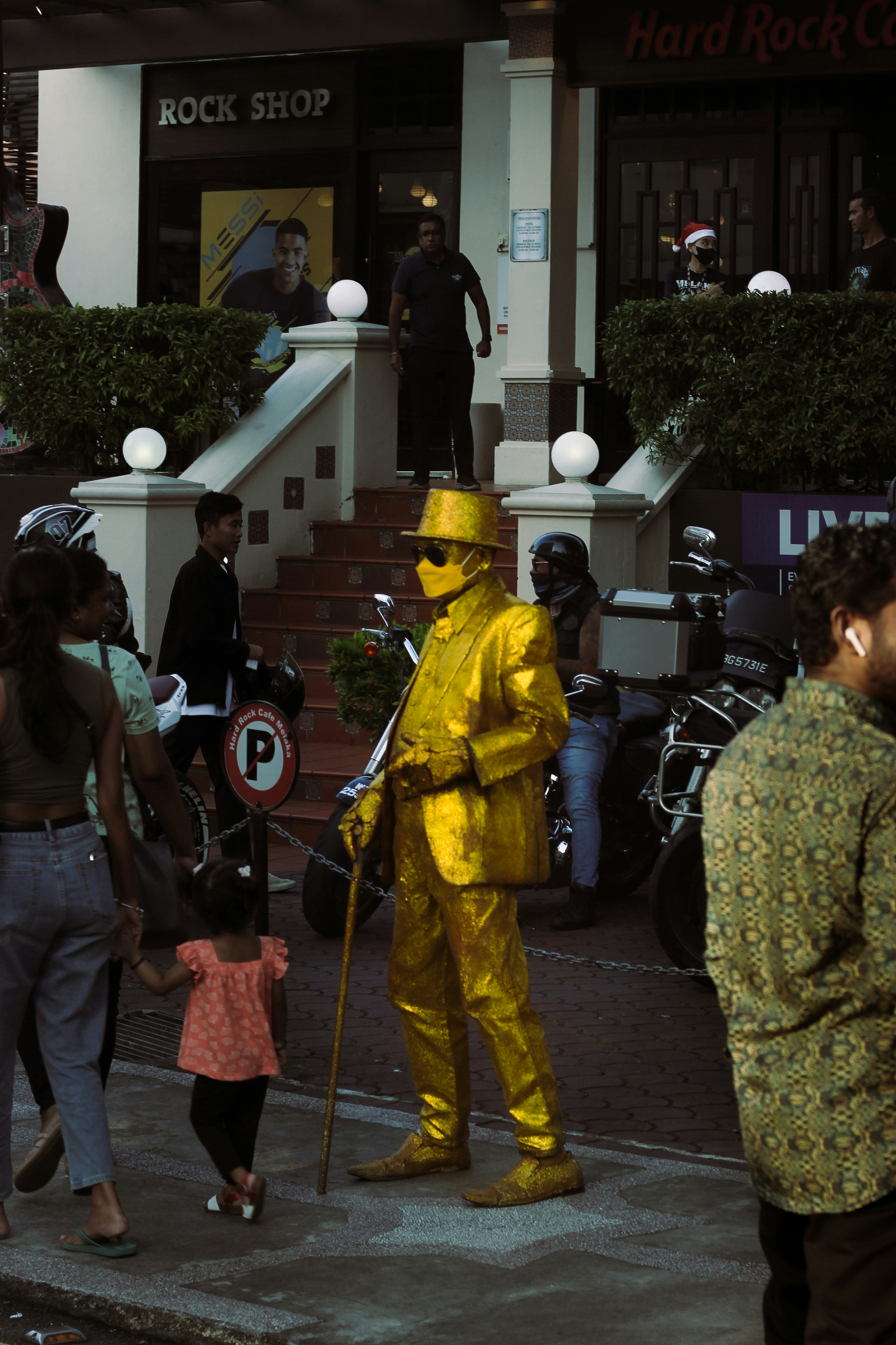 Gilded Street Performer in Front of a Rock Shop