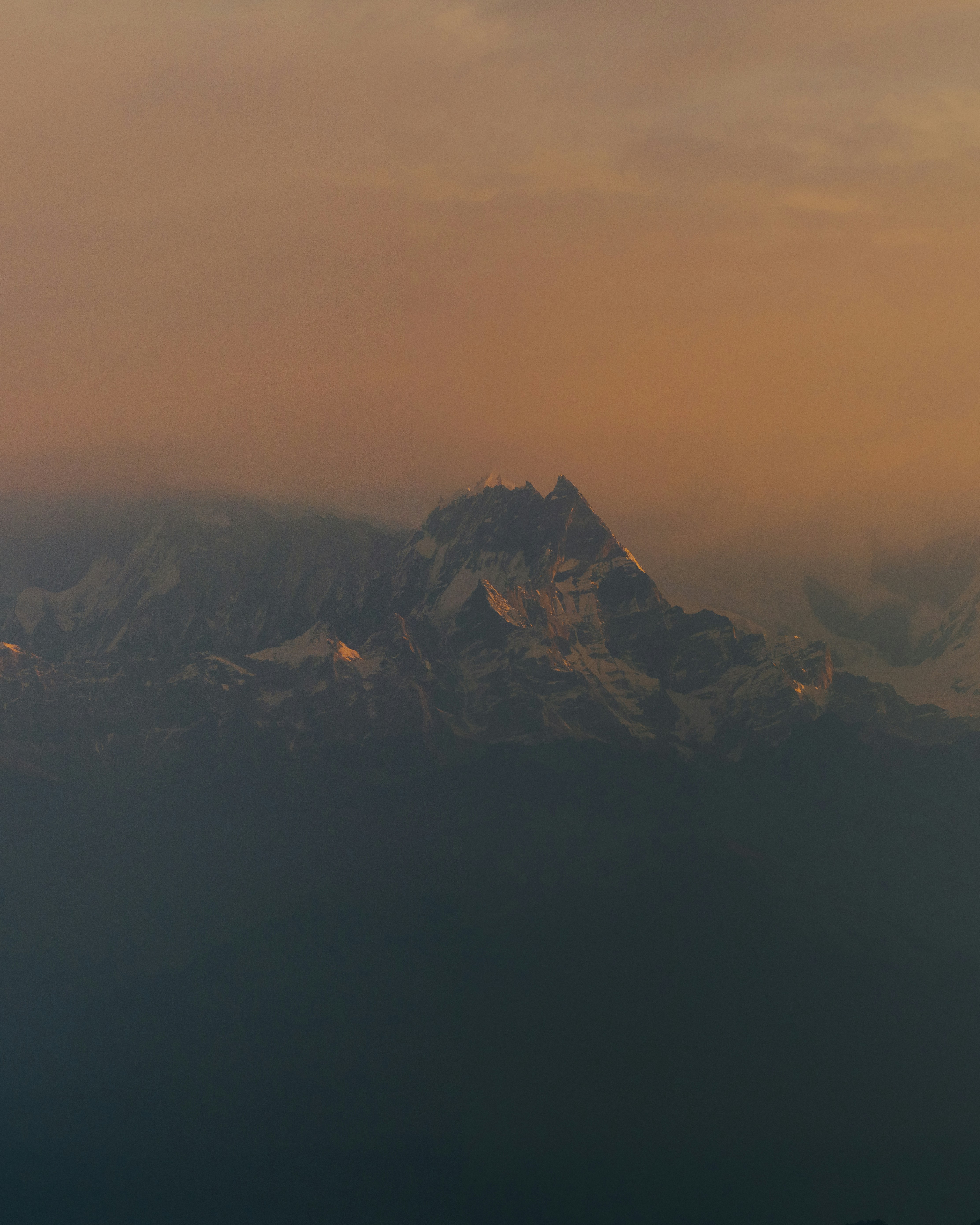 Golden Haze Over Himalayan Peaks