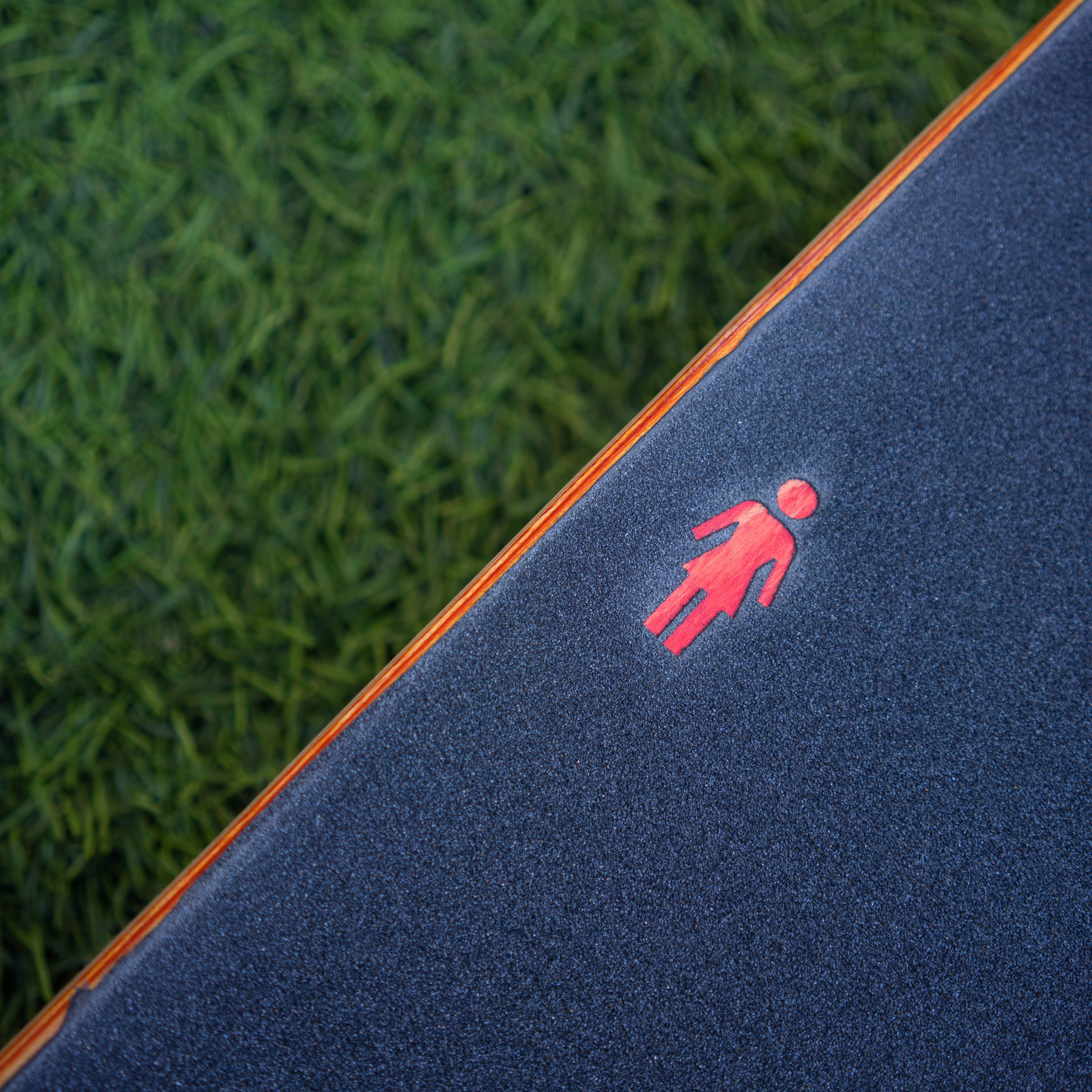 Glyph on the Grind: Red Pedestrian Logo on a Textured Blue Deck with Orange Trim