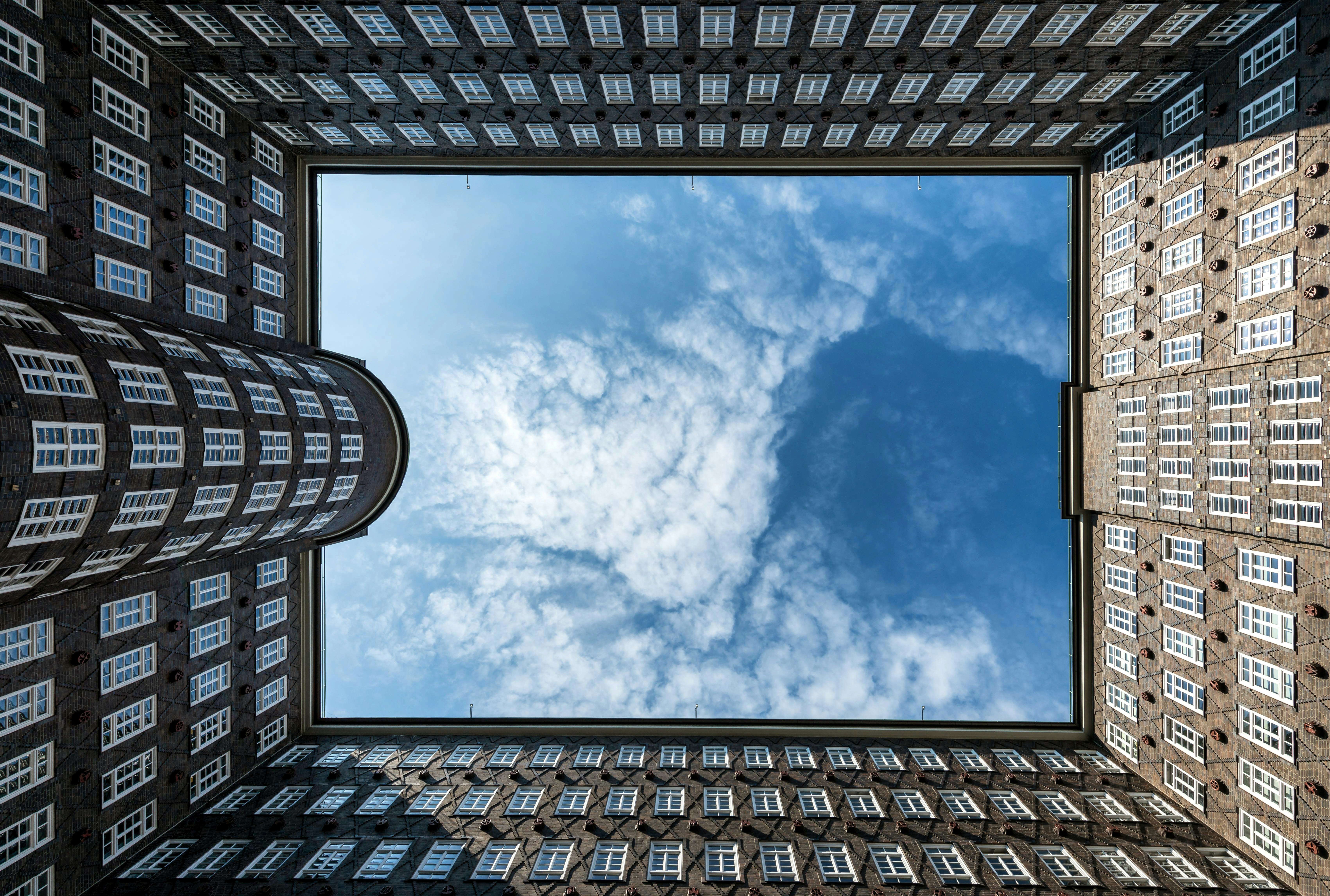 A view of a building from the ground looking up at the sky photo – Free ...
