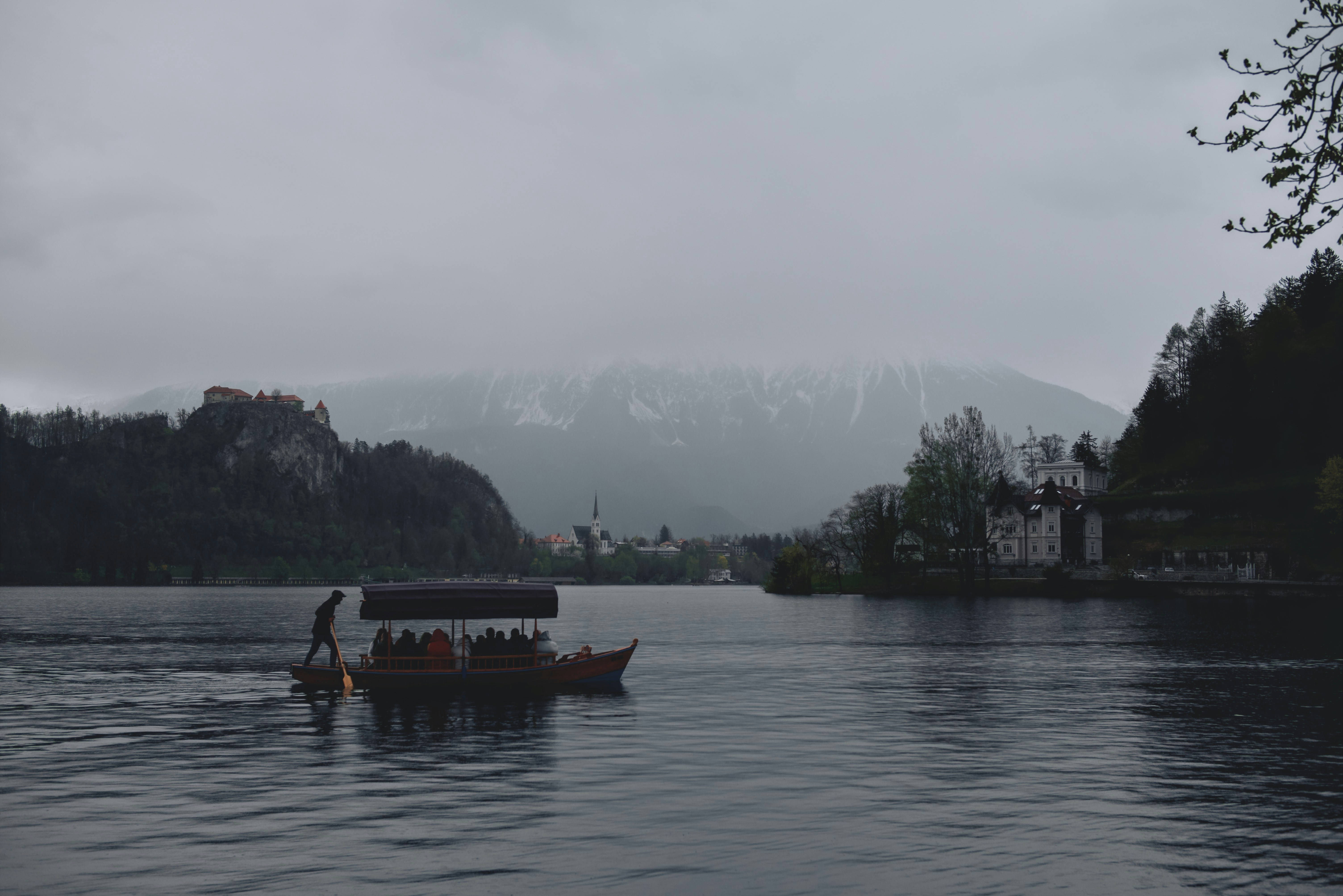 Misty Lake Voyage beneath Majestic Peaks