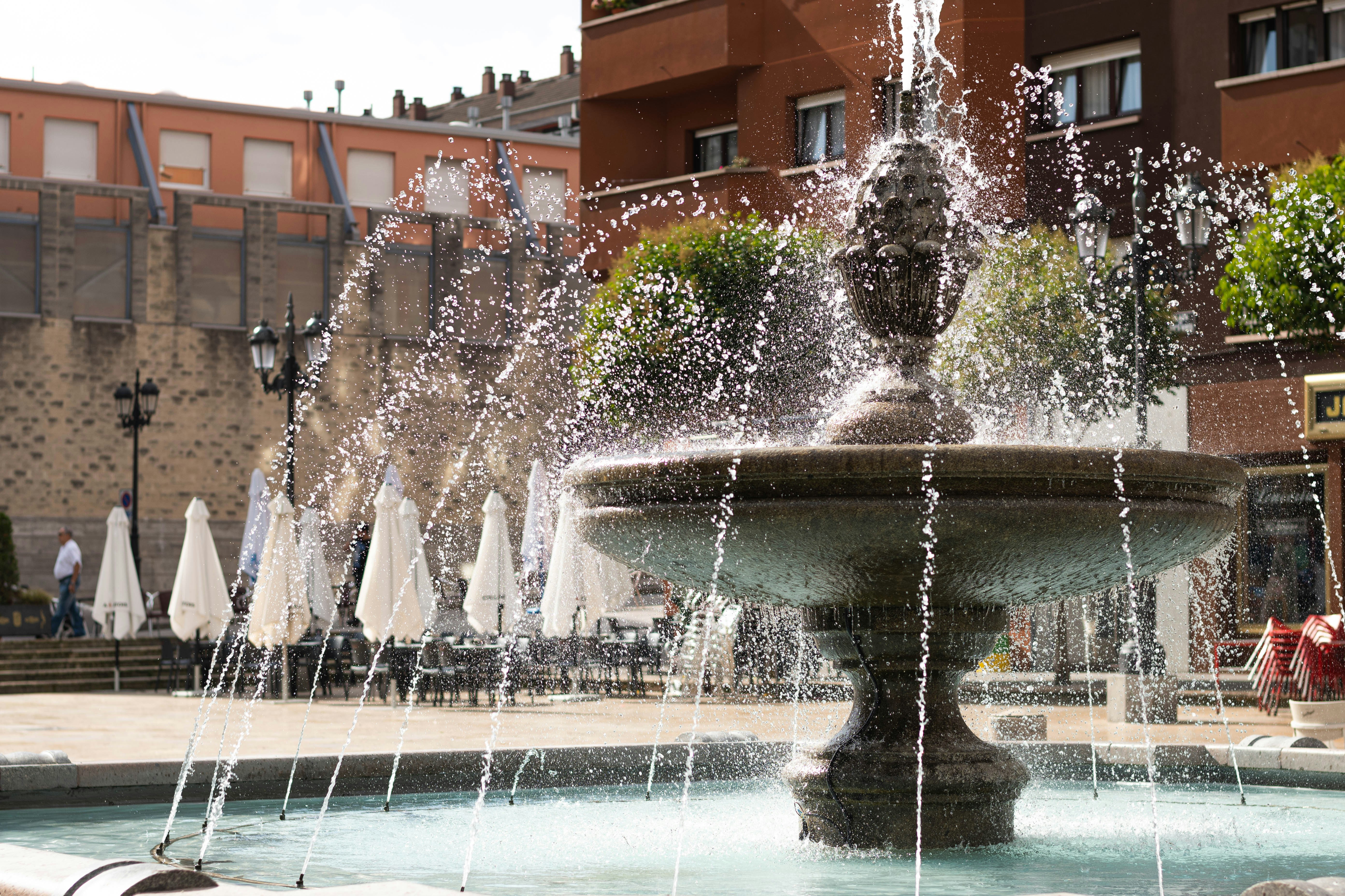 A fountain with water spouting out of it photo – Free Spain Image on ...