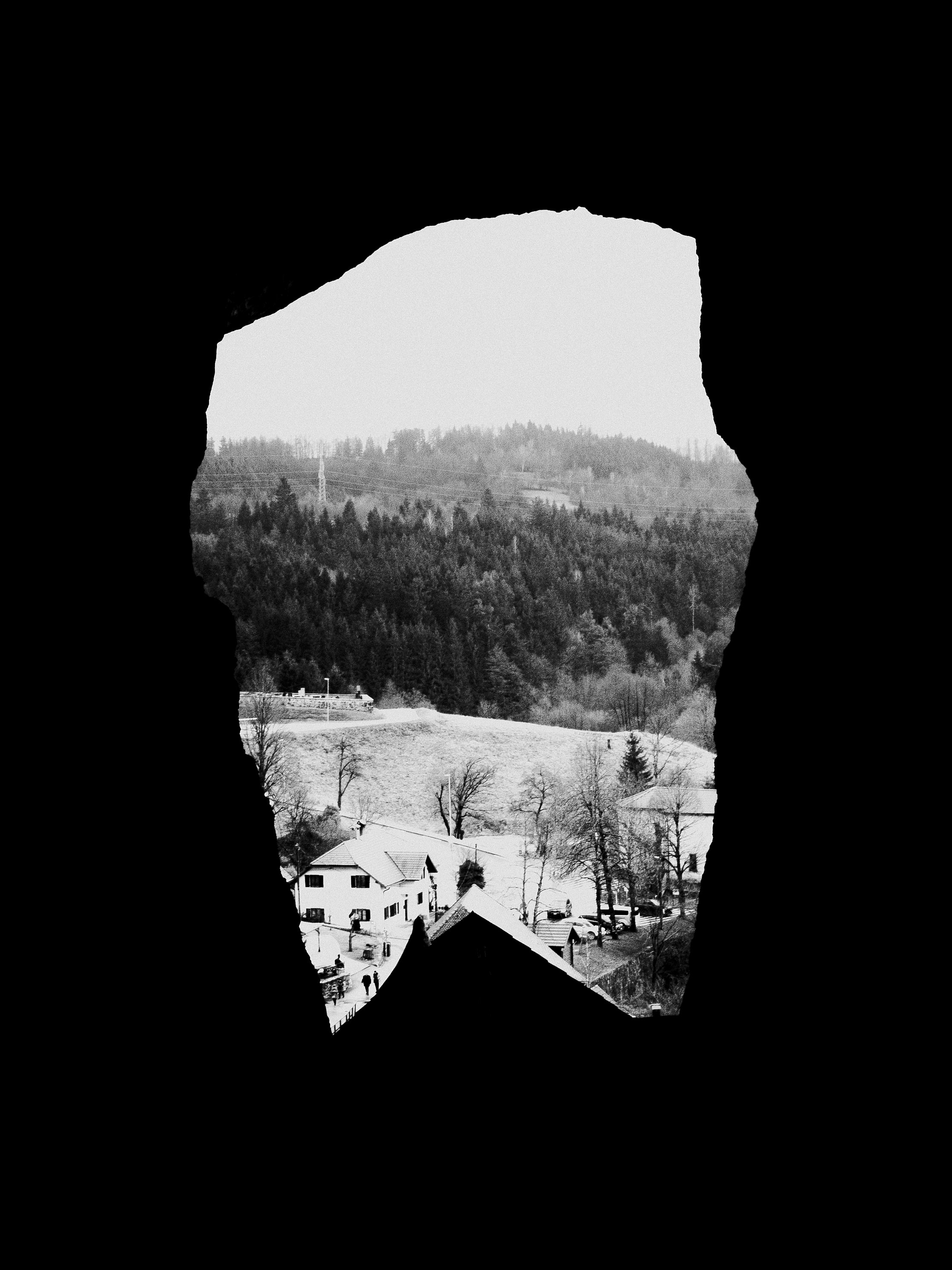 Light Through the Cave: Snowy Village Framed by Dark Silhouette