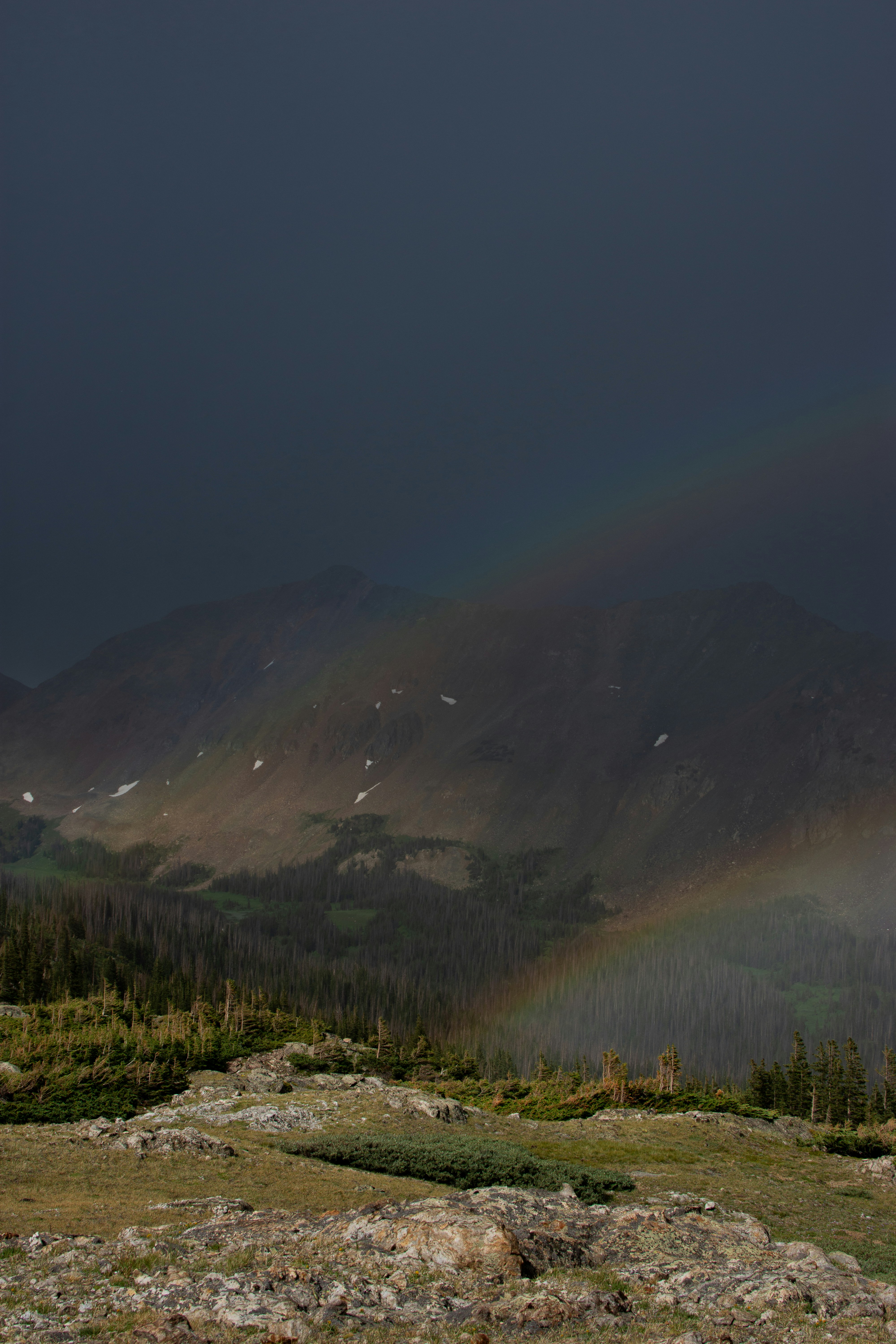Double Rainbow Over a Rugged Alpine Ridge at Dusk