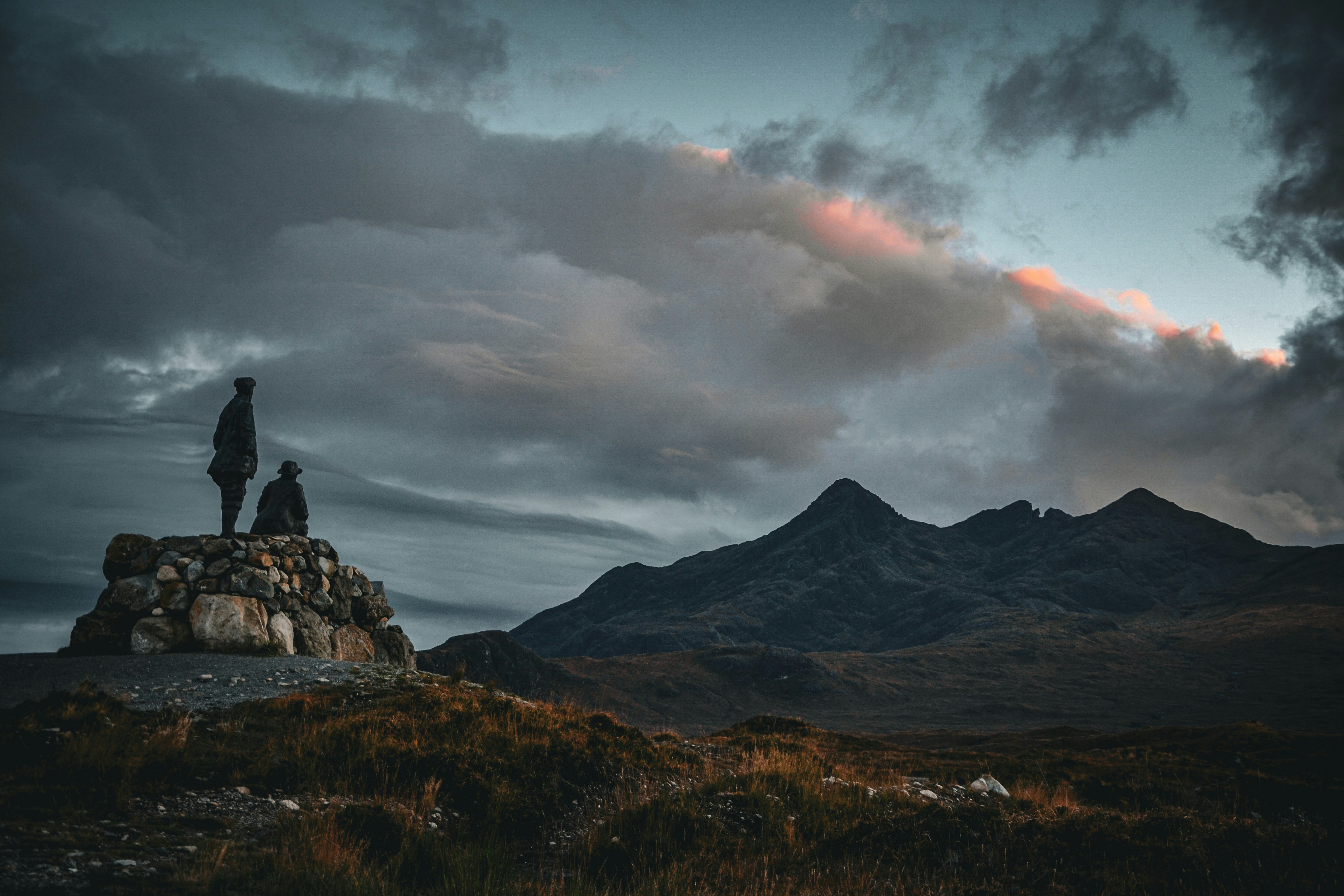 Two Silent Sentinels on a Stone Cairn at Dusk