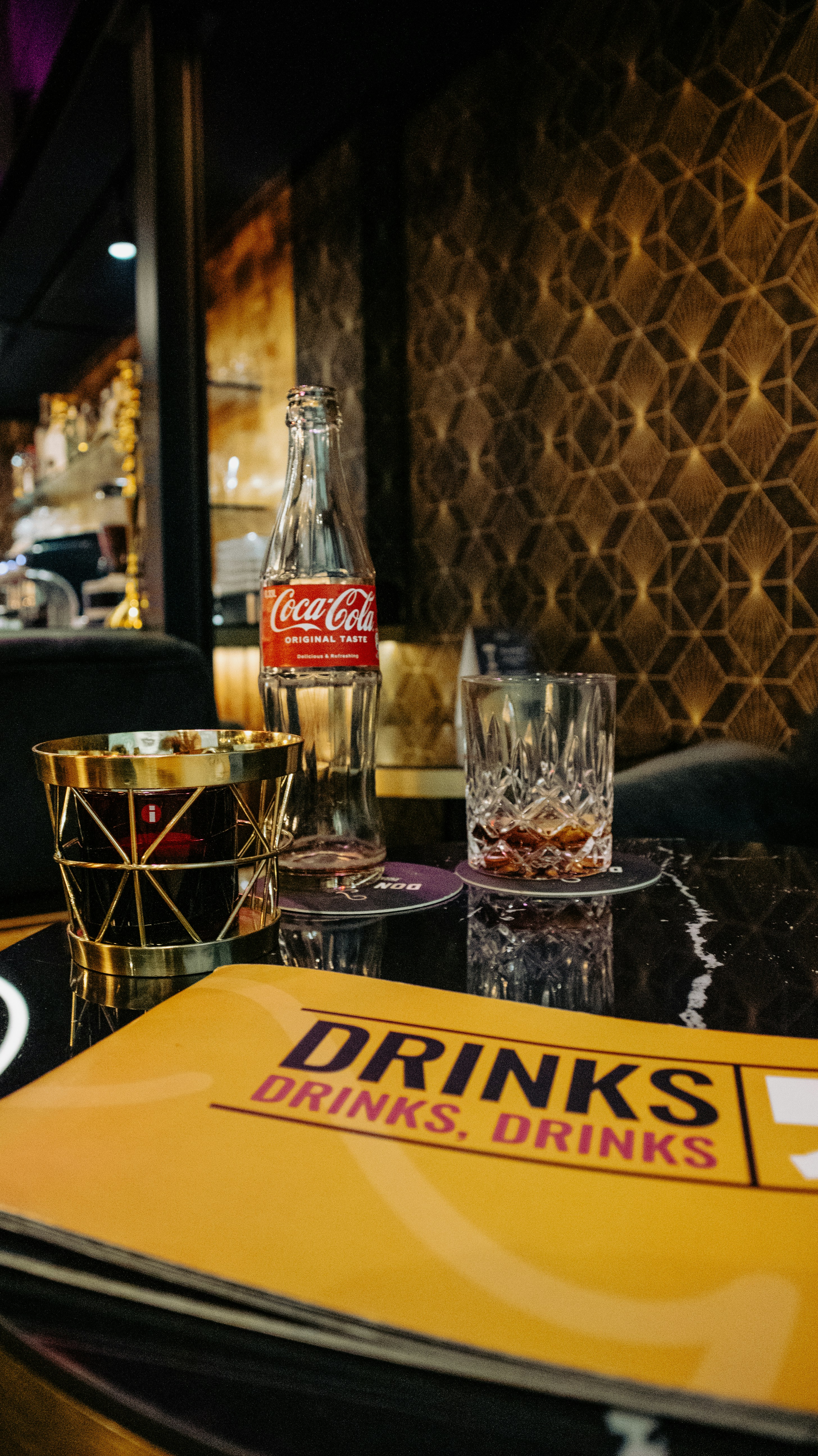 Red Label in the Warm Glow: Coca-Cola, Crystal Glass, and a Bar Counter