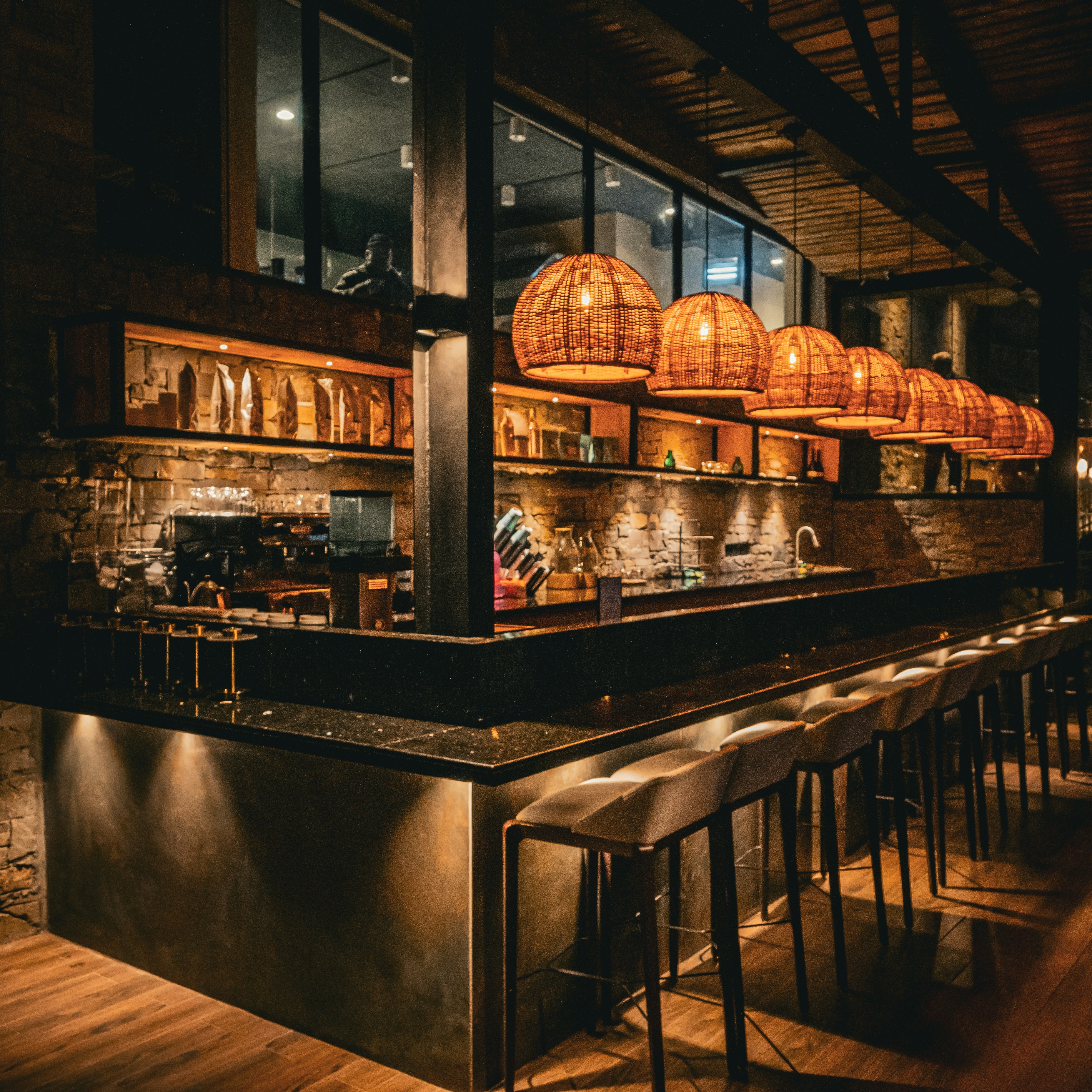 A bar with a bunch of stools in front of it photo – Free Building Image ...
